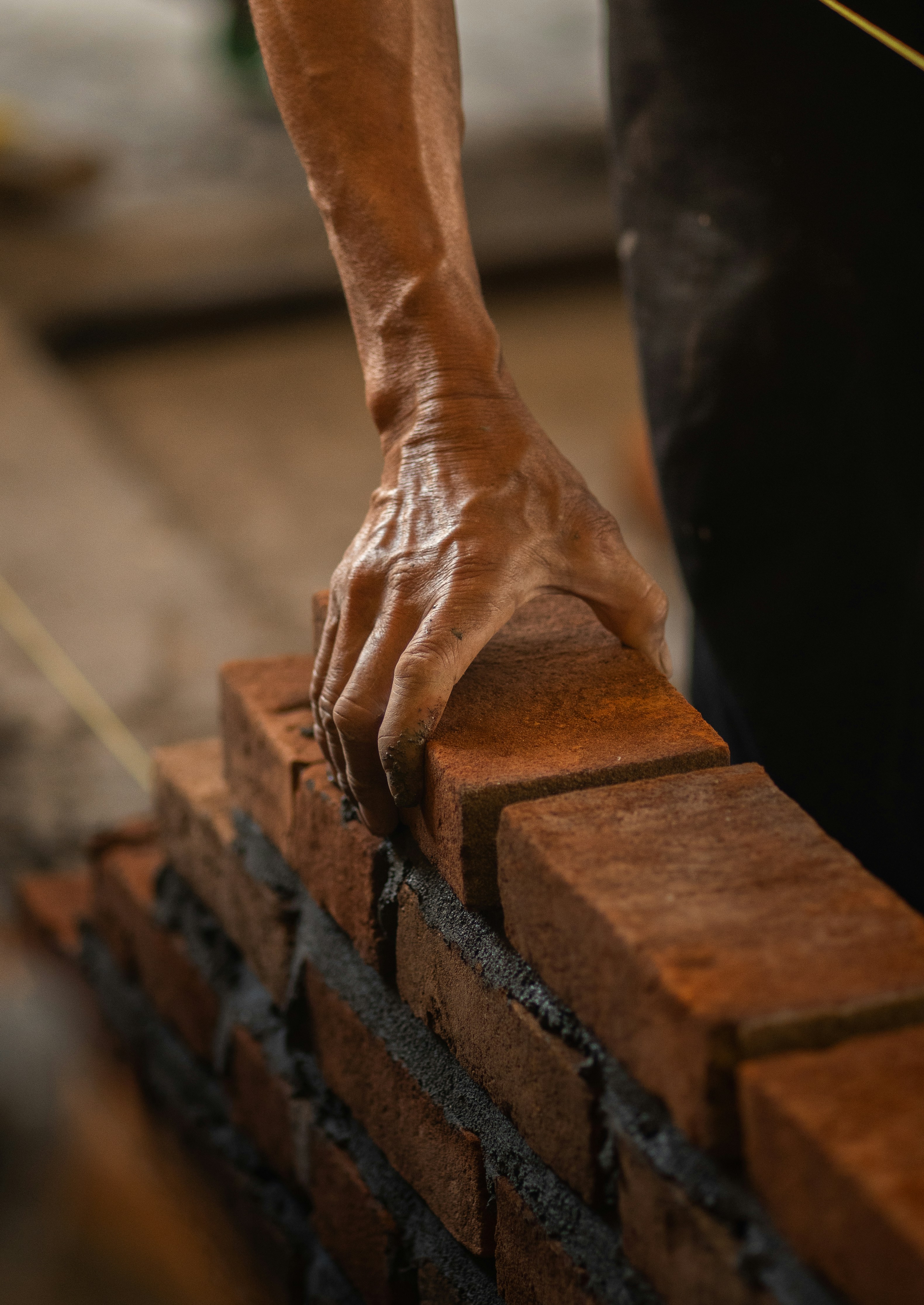 Brick-by-Brick: A Workman’s Hand Shapes a New Wall