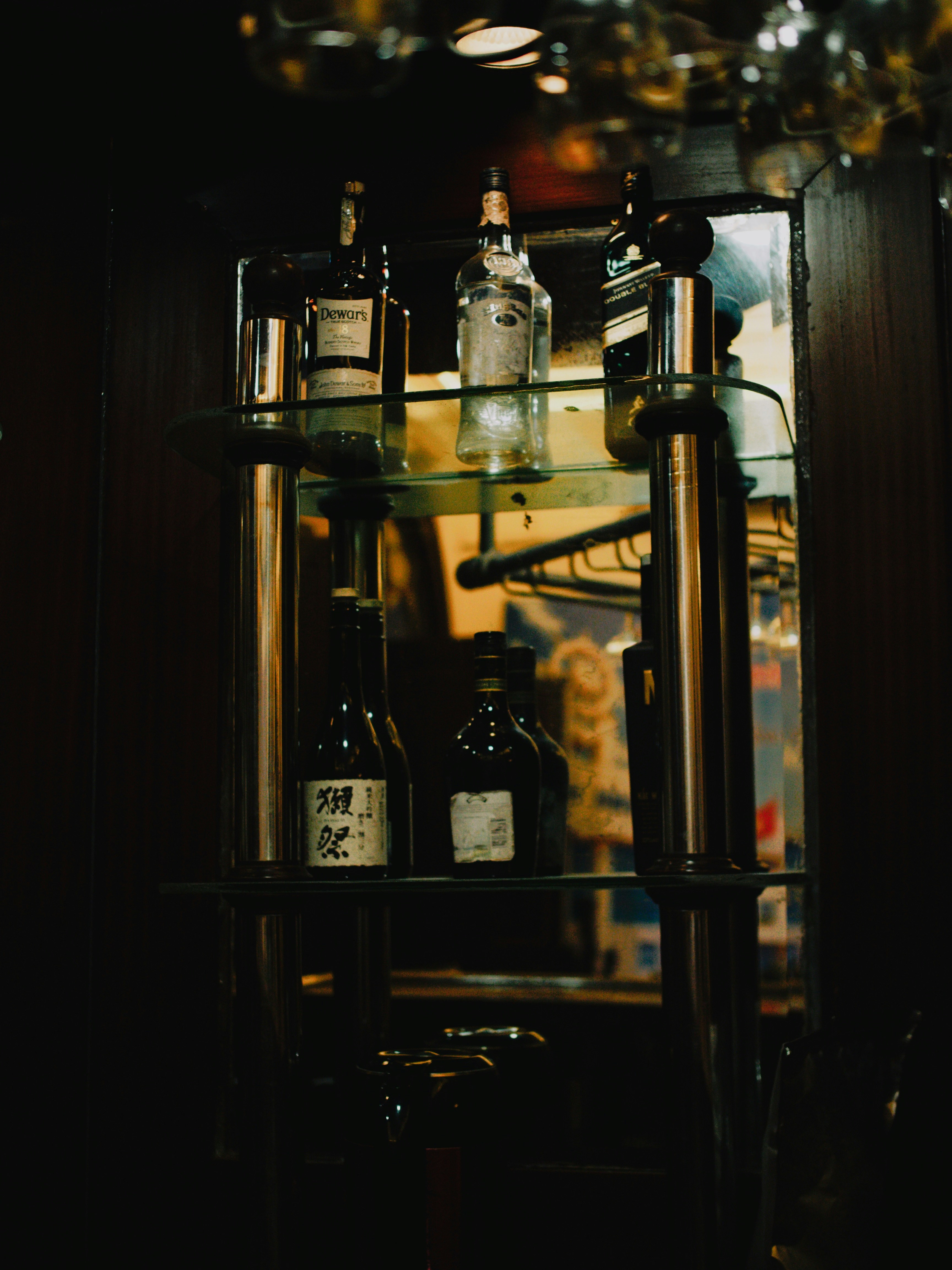 Midnight Shelf: Bottles Aligned Under Ambient Bar Lights
