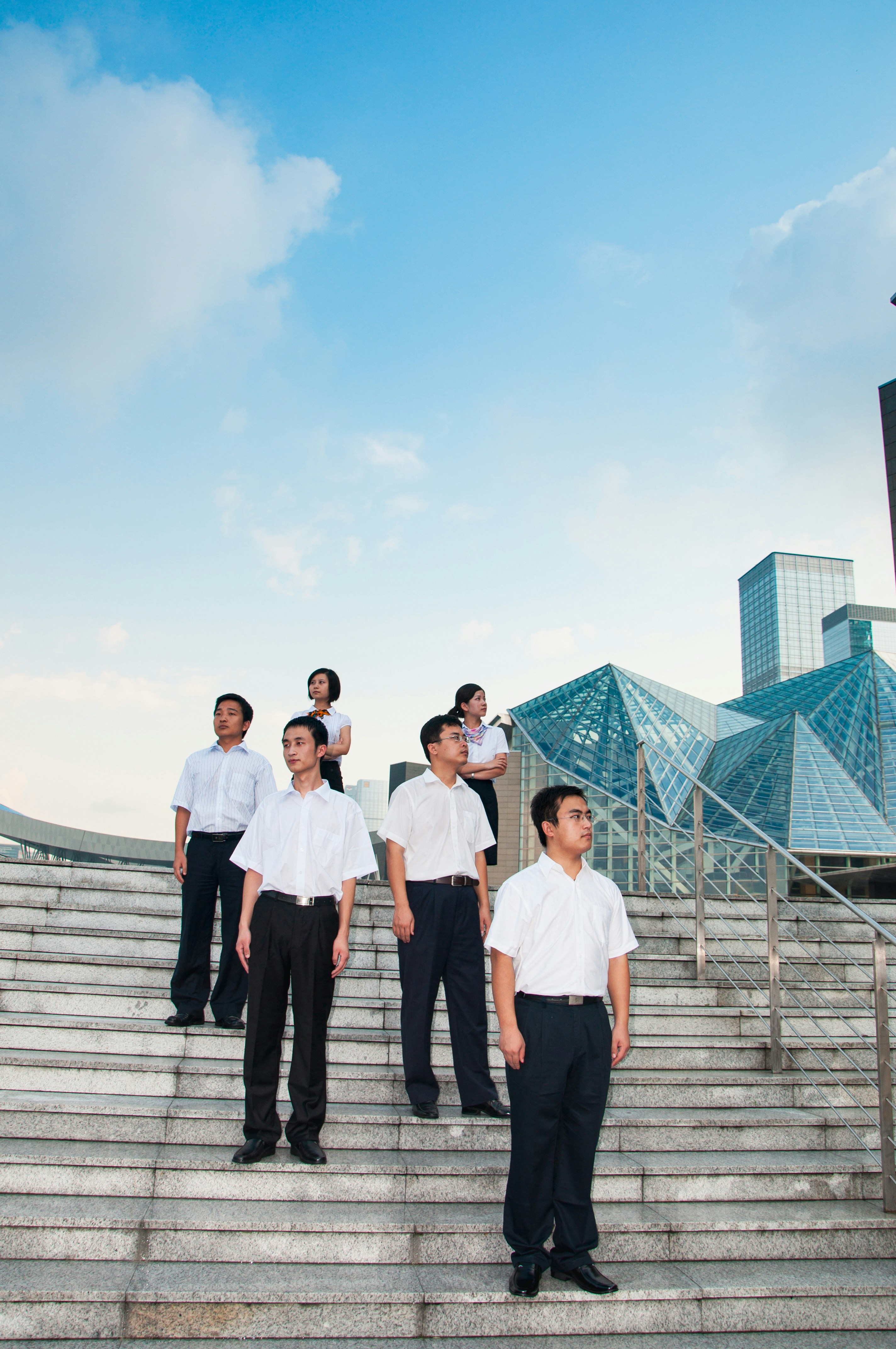 Staircase Ensemble: Group of Professionals Amid Modern Architecture