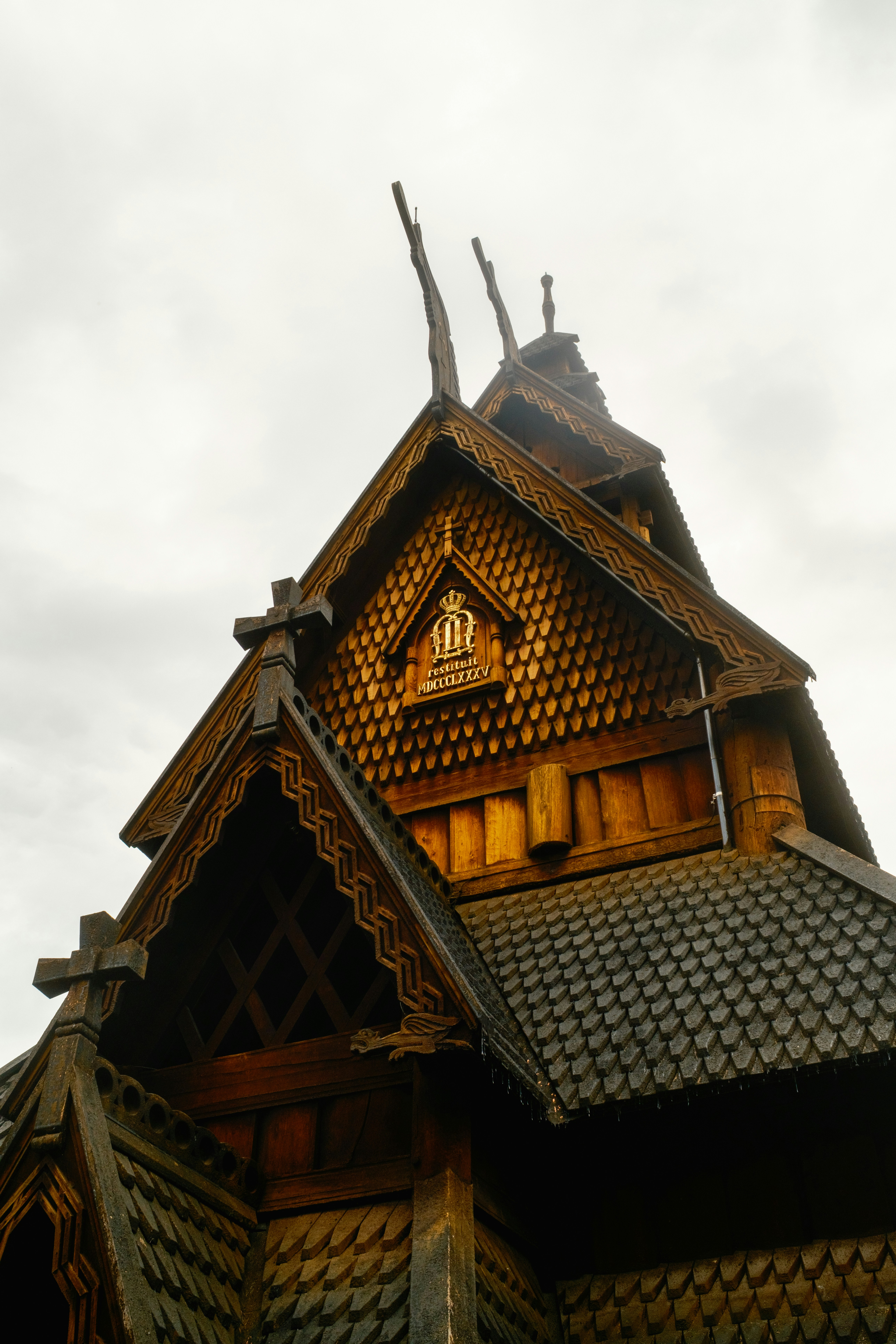 Ornate Timber-Paneled A-frame Shrine Reaching Toward the Overcast Sky