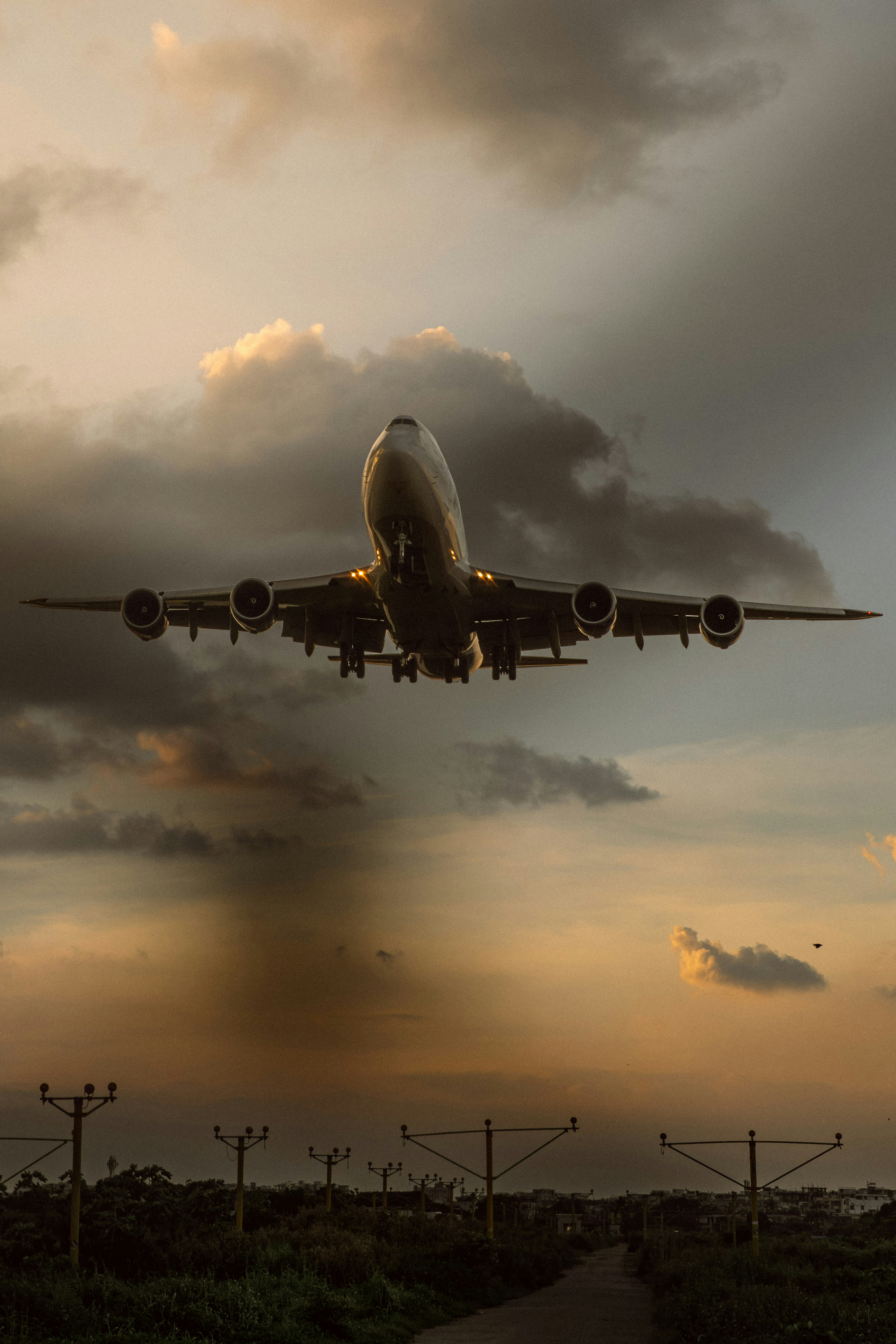 Midflight Giant: A Jet Emerges from the Dusk Above a Quiet Ramp