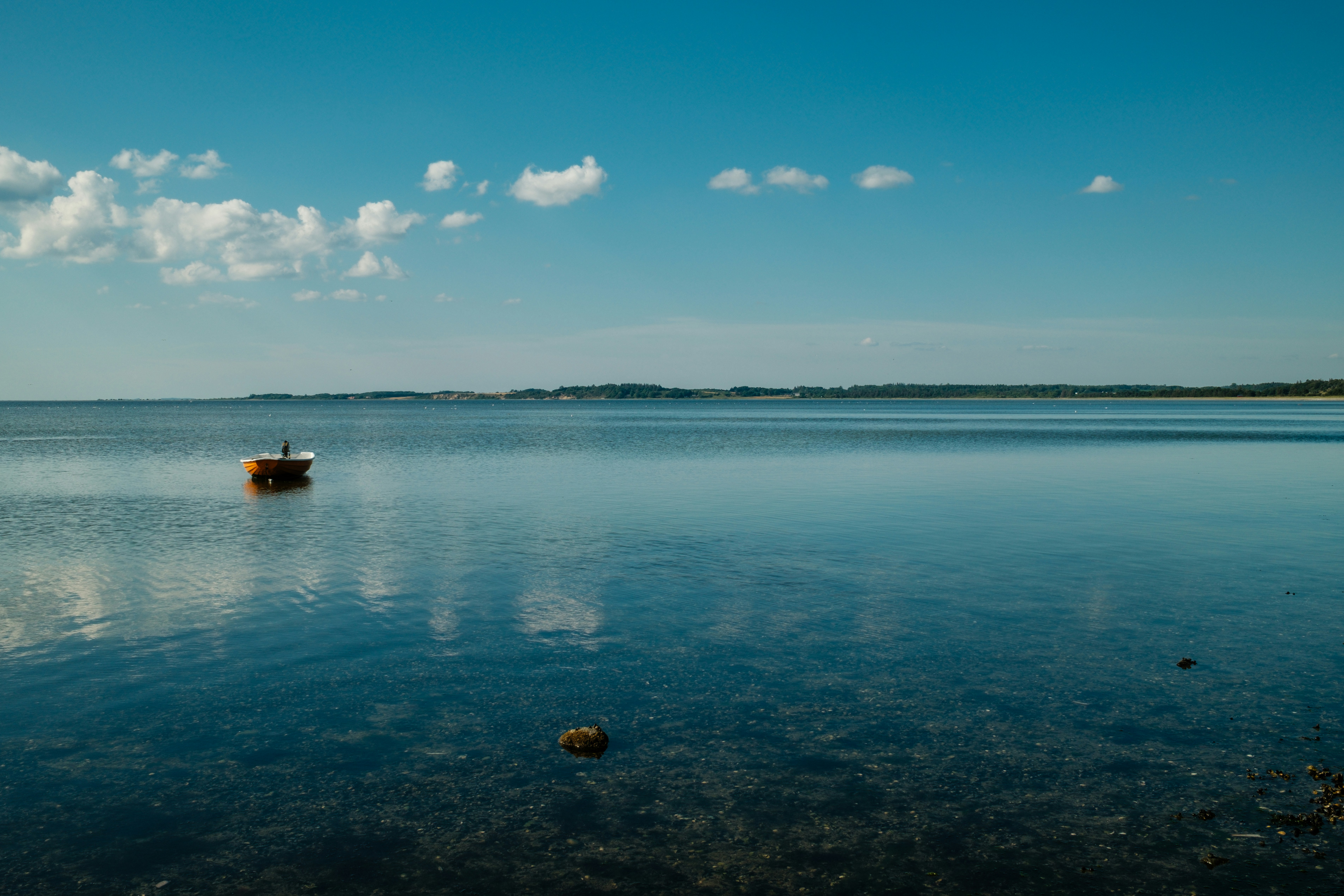 Lone Boat on a Quiet Coastal Plane at Dusk