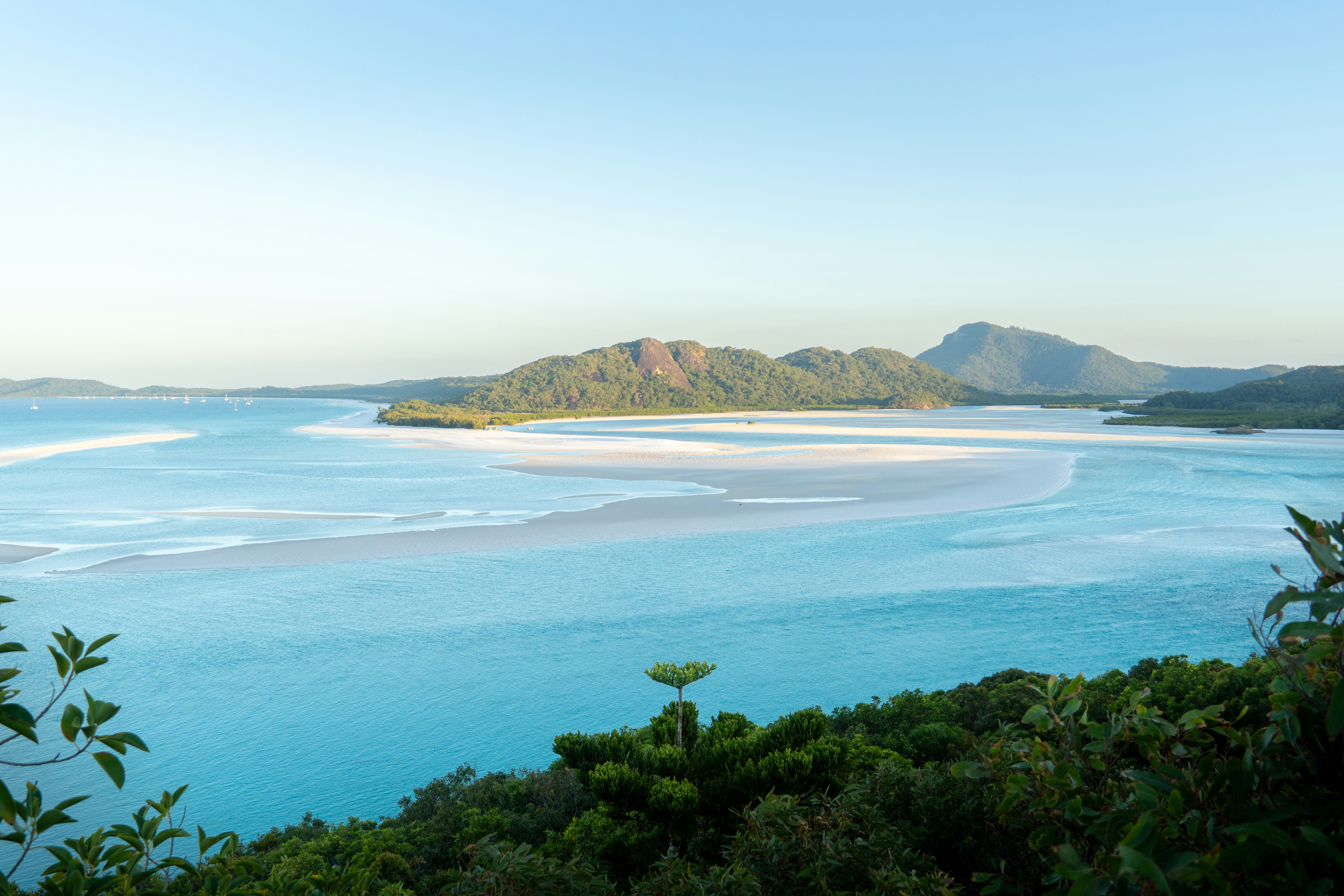 Azure Peninsula: Coral-tinged Waters Meet a Quiet Ridge
