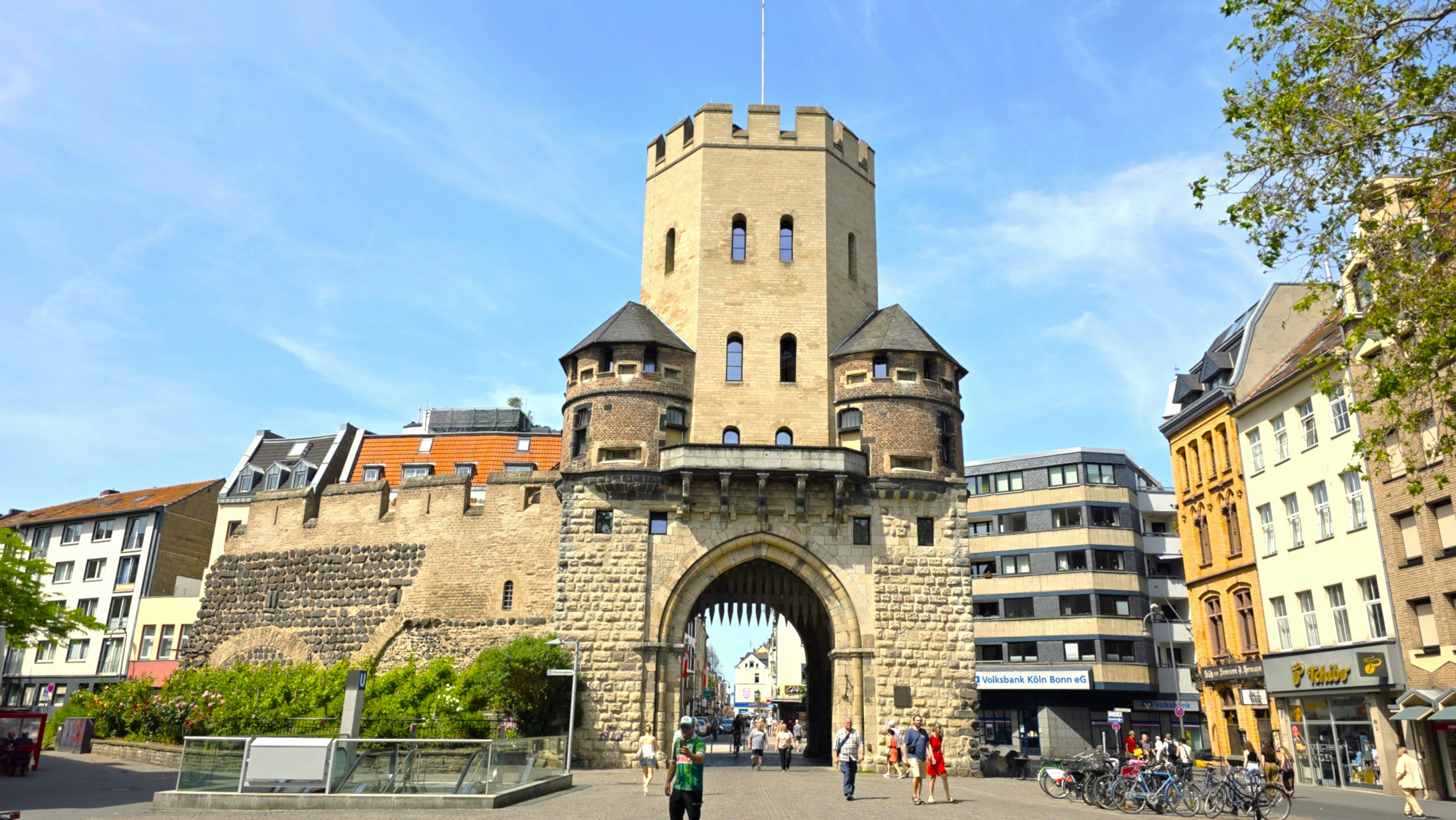 Gateway to the Old Town: A Sunlit Arch Between Modern Facades