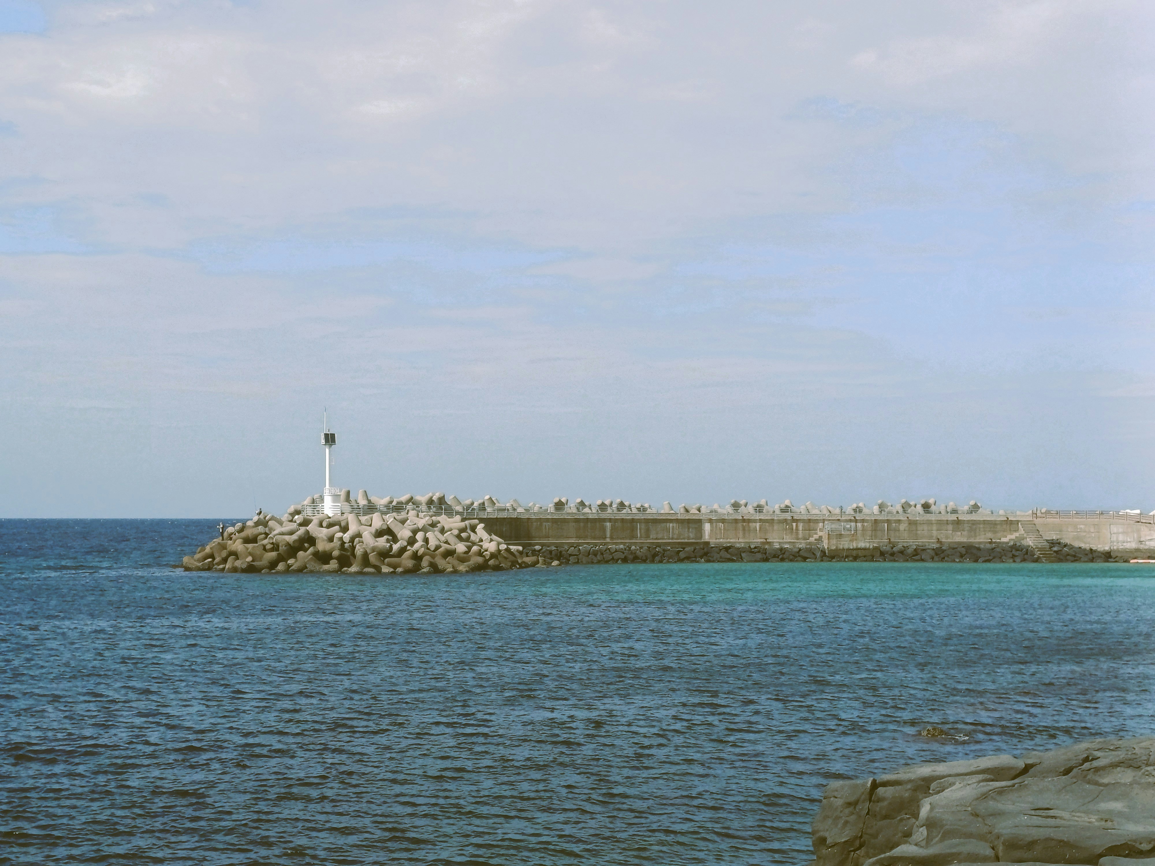 Breakwater Sentinel: A Quiet Sea Pier Reaches Toward the Horizon