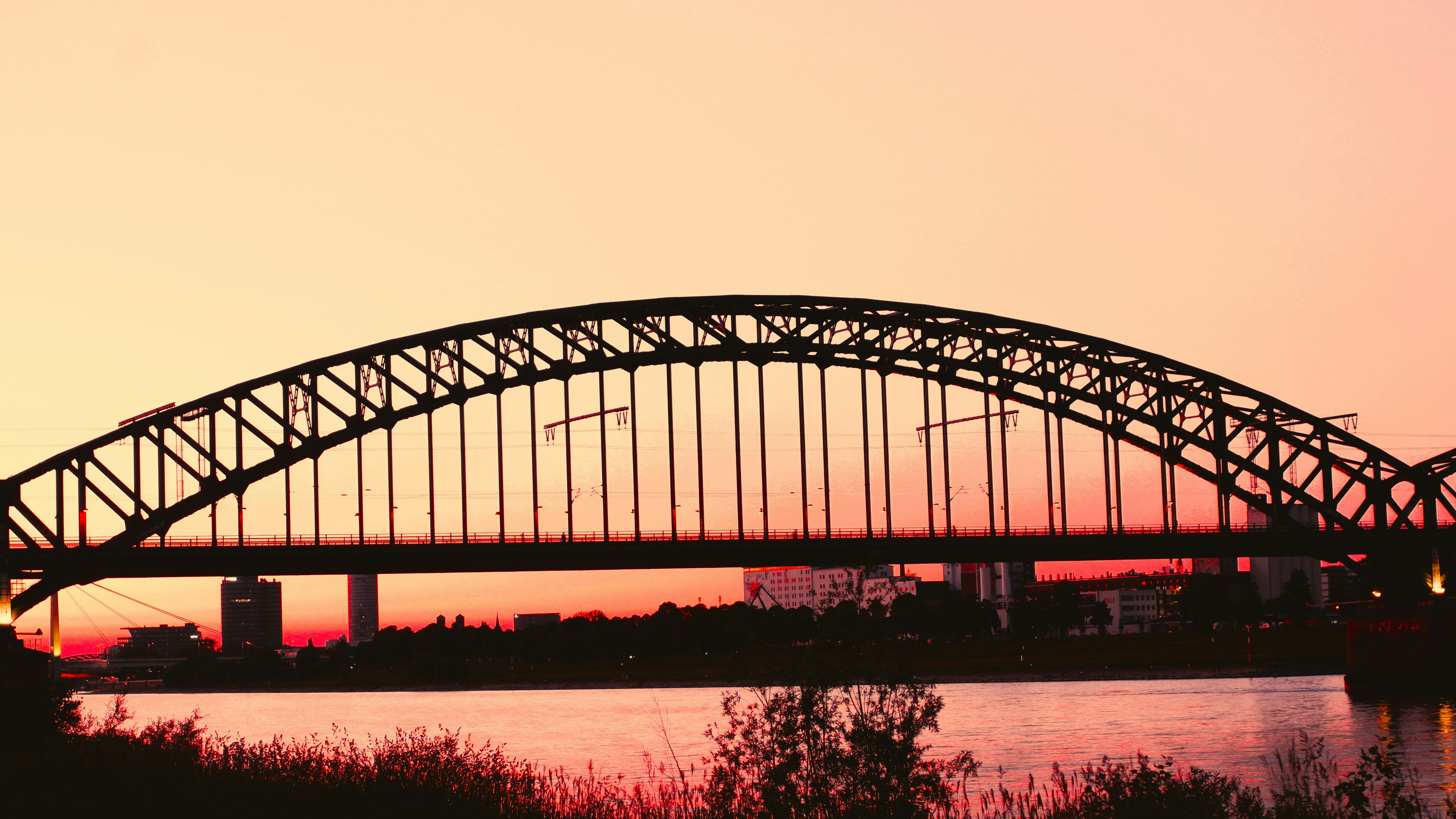 Sunset Over the Arch: A Silhouette of the River Bridge