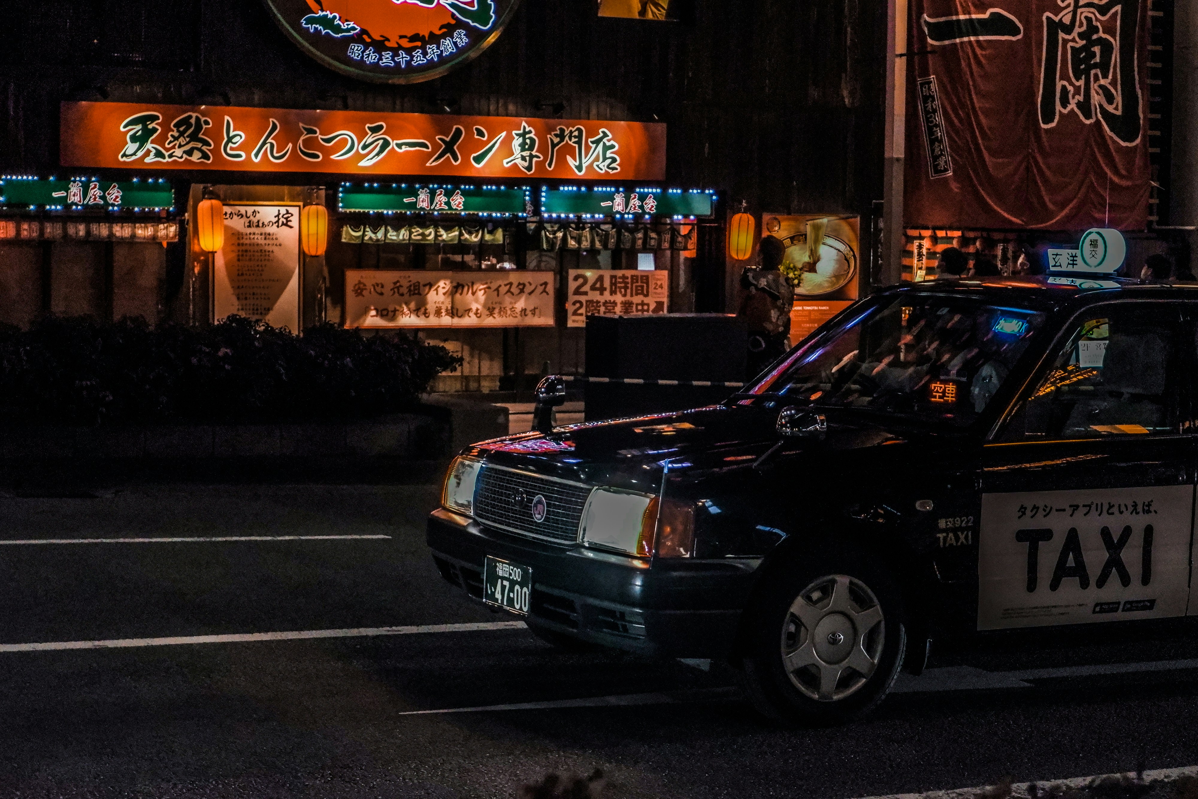 Night Taxi frame: Neon ramen glow over a parked Tokyo cab