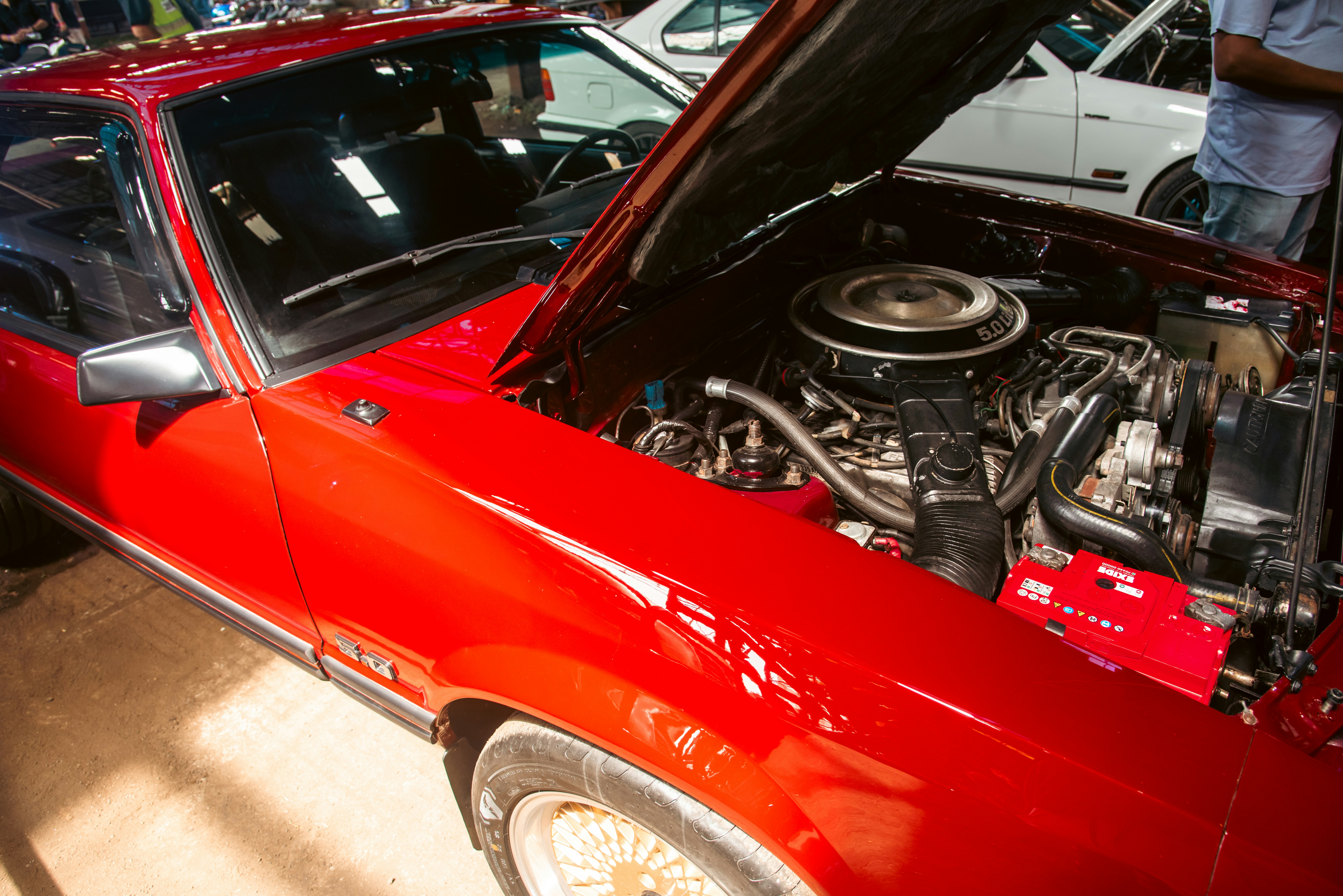 Red Classic: A Vivid Car Hood and Engine Portrait