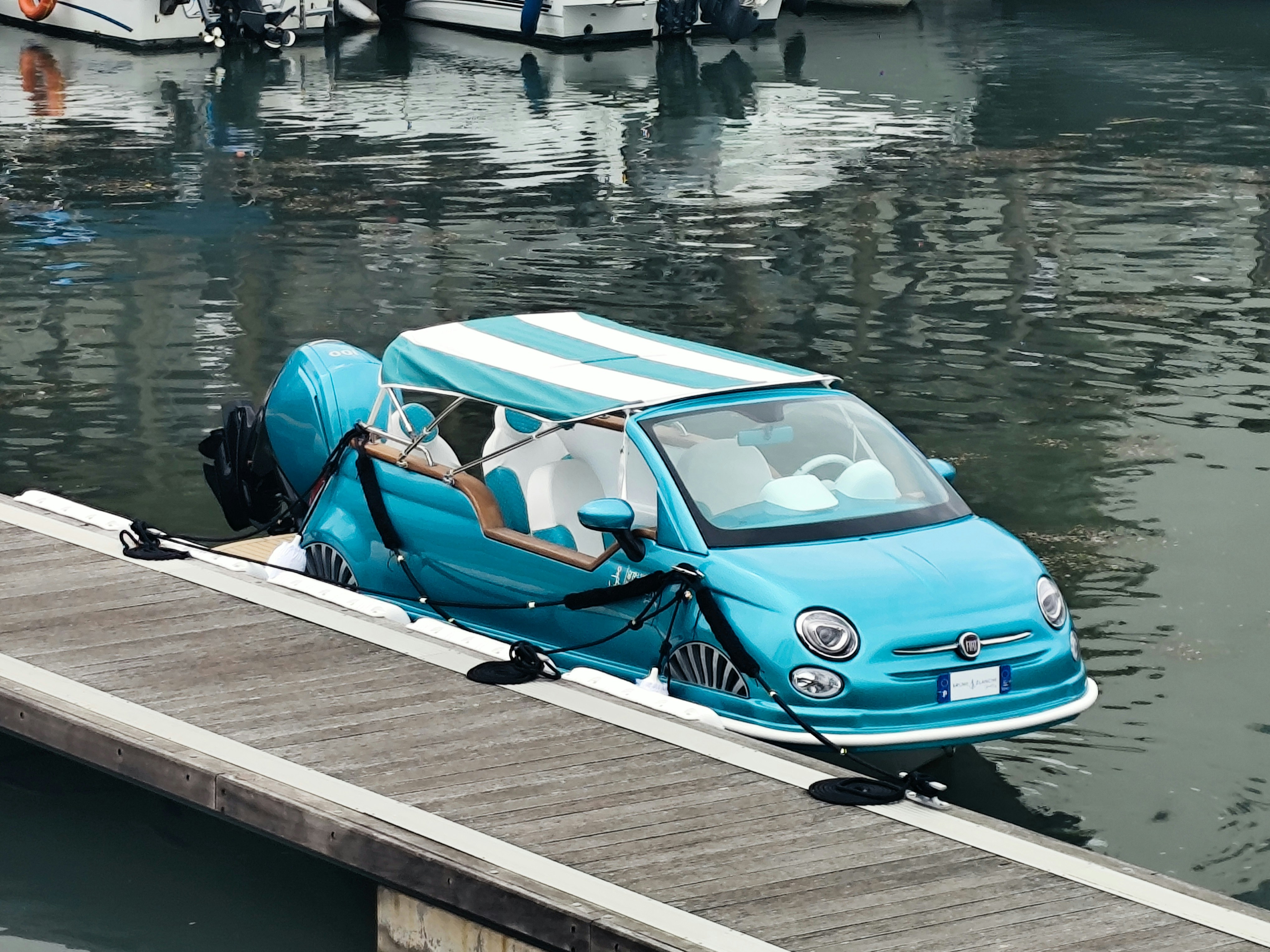 Turquoise Sea-Spawned Runabout Docked at a Quiet Pier