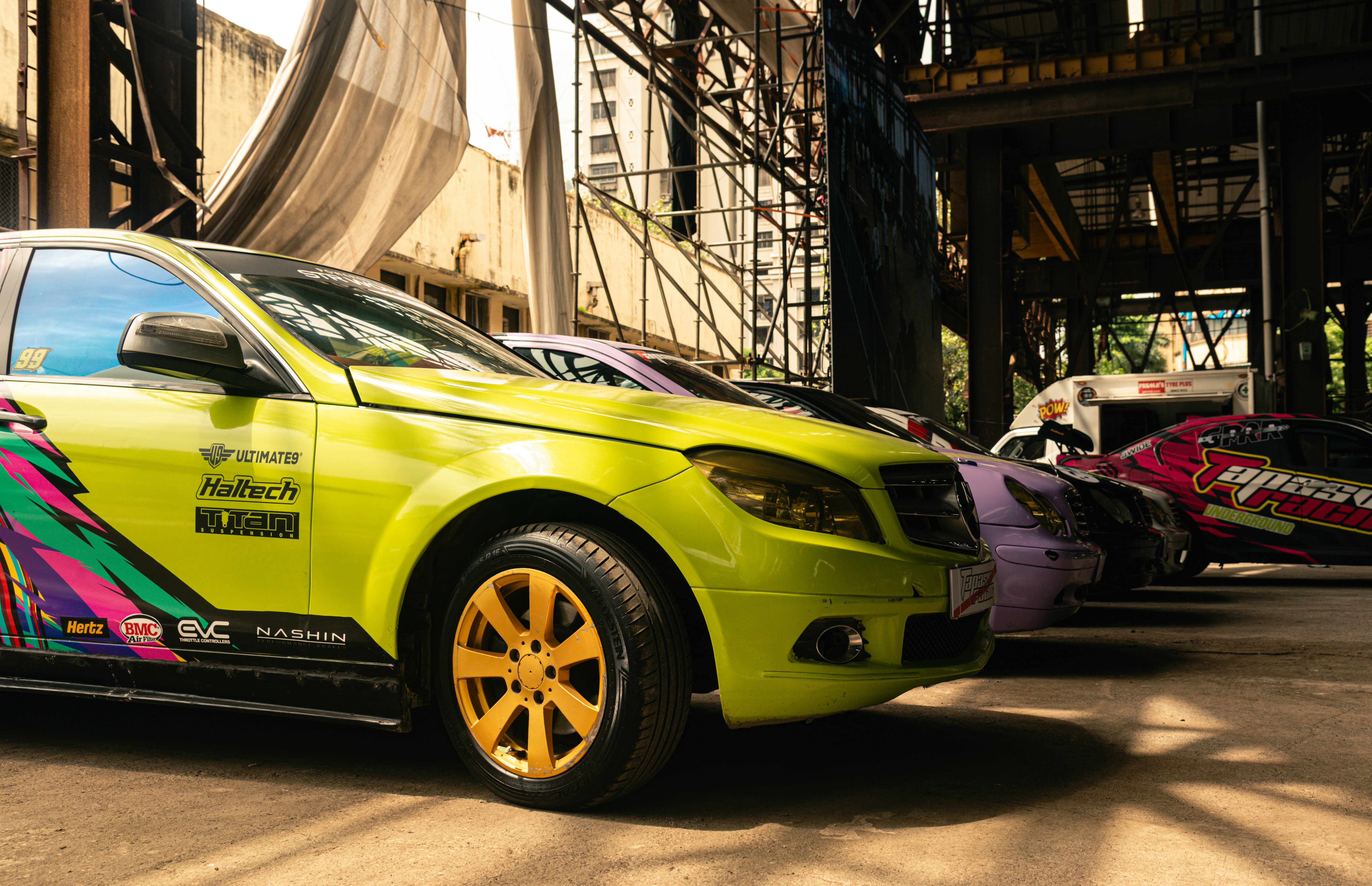 Lime-green Racing Sedan in a sunlit industrial showroom