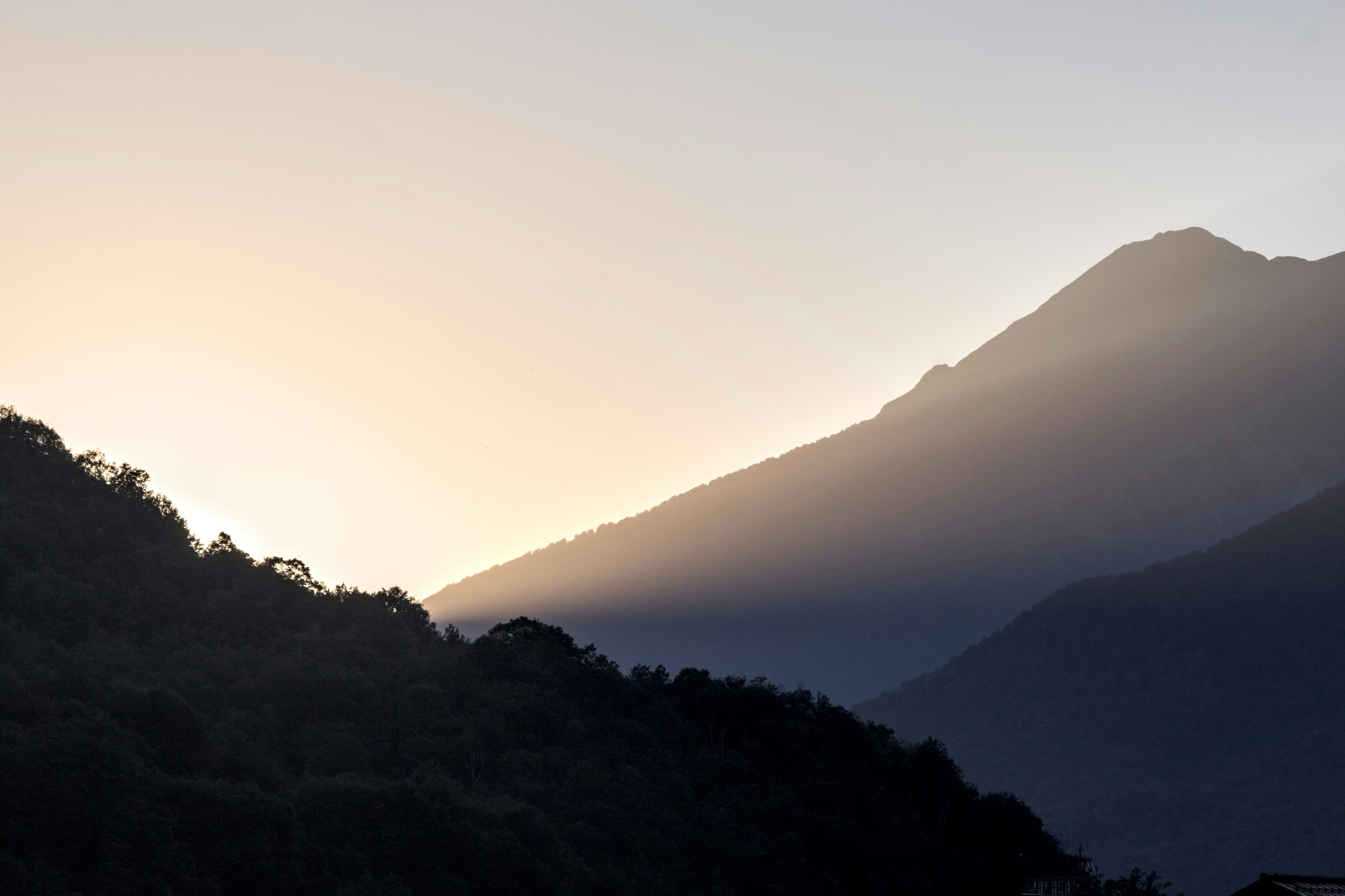 Dawn Over the Ridge: Shadowed Valleys and a Velvet Skyline