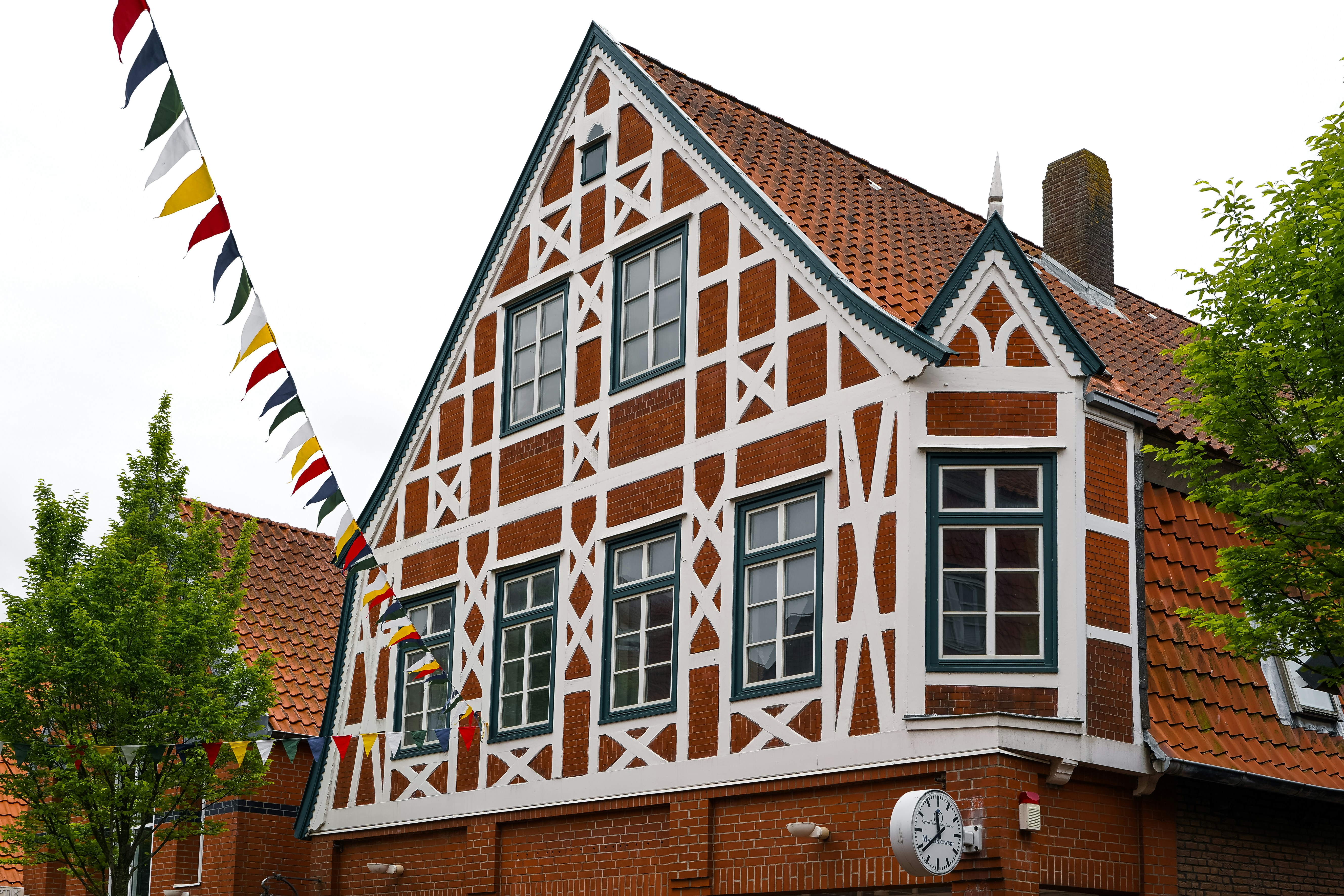 Timbered Facade in a Festival-Flagged Town