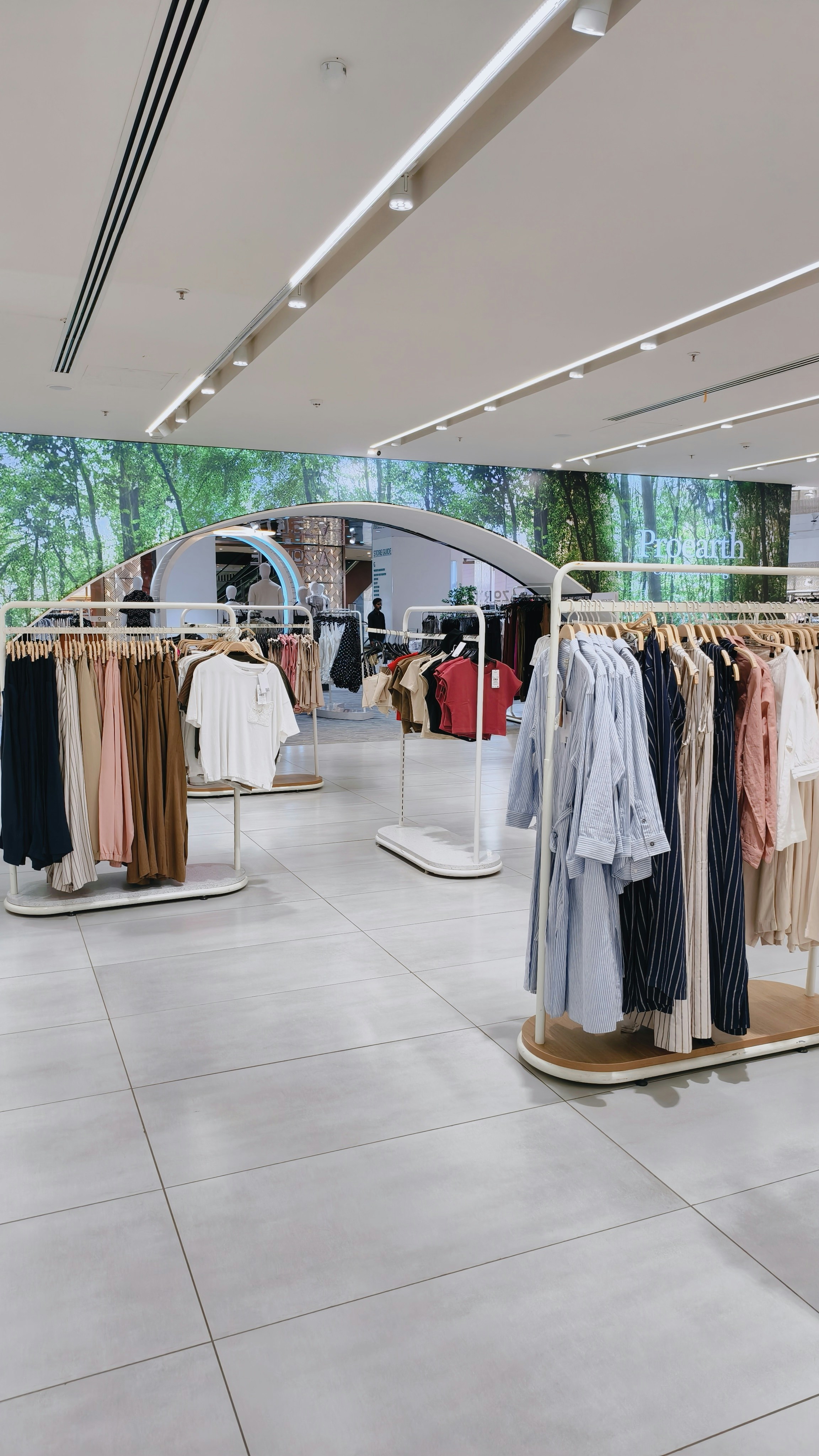Neatly organized apparel racks frame a contemporary store interior