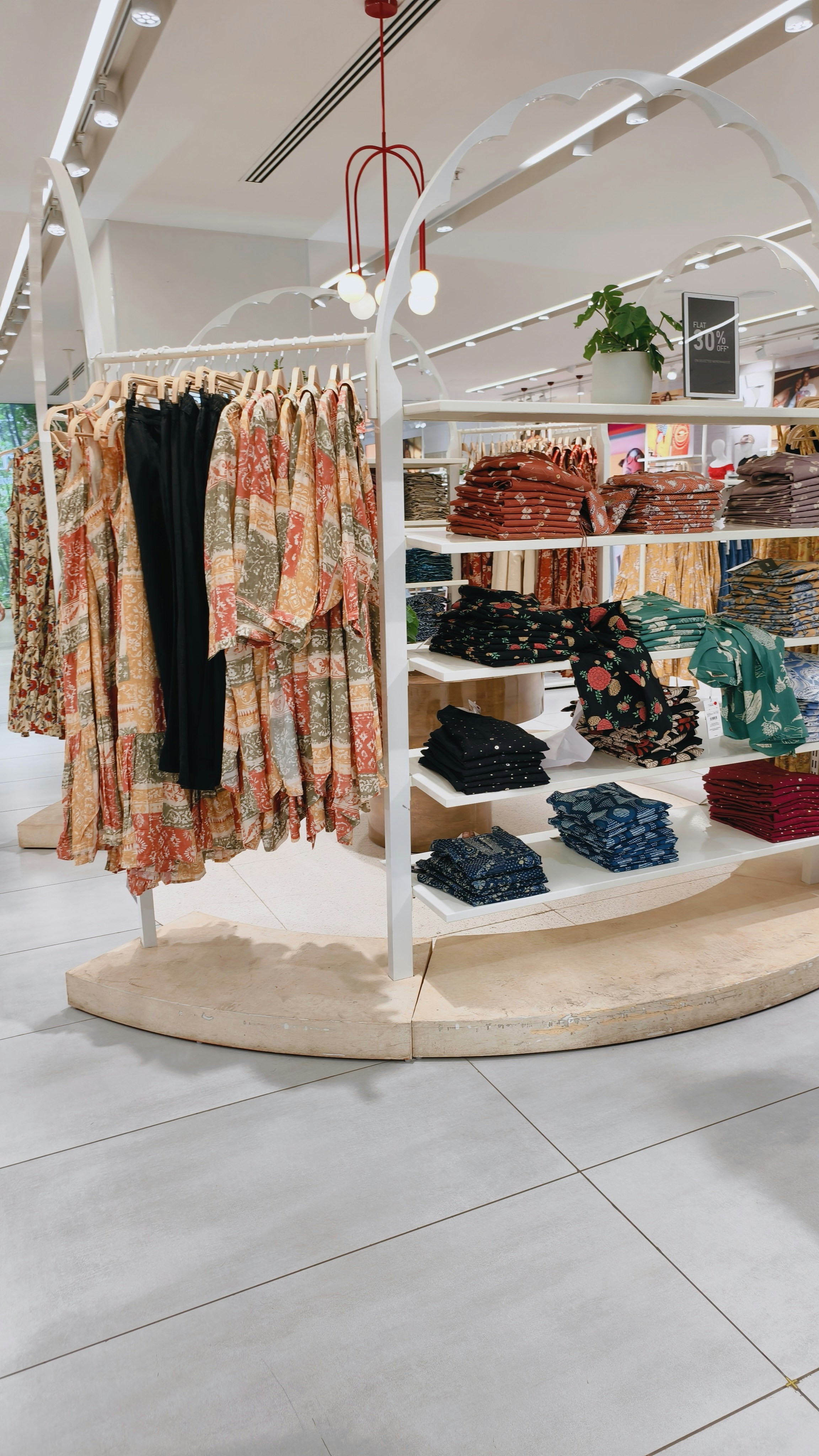 Curated Display: Floral Dresses on a Circular Fashion Rack