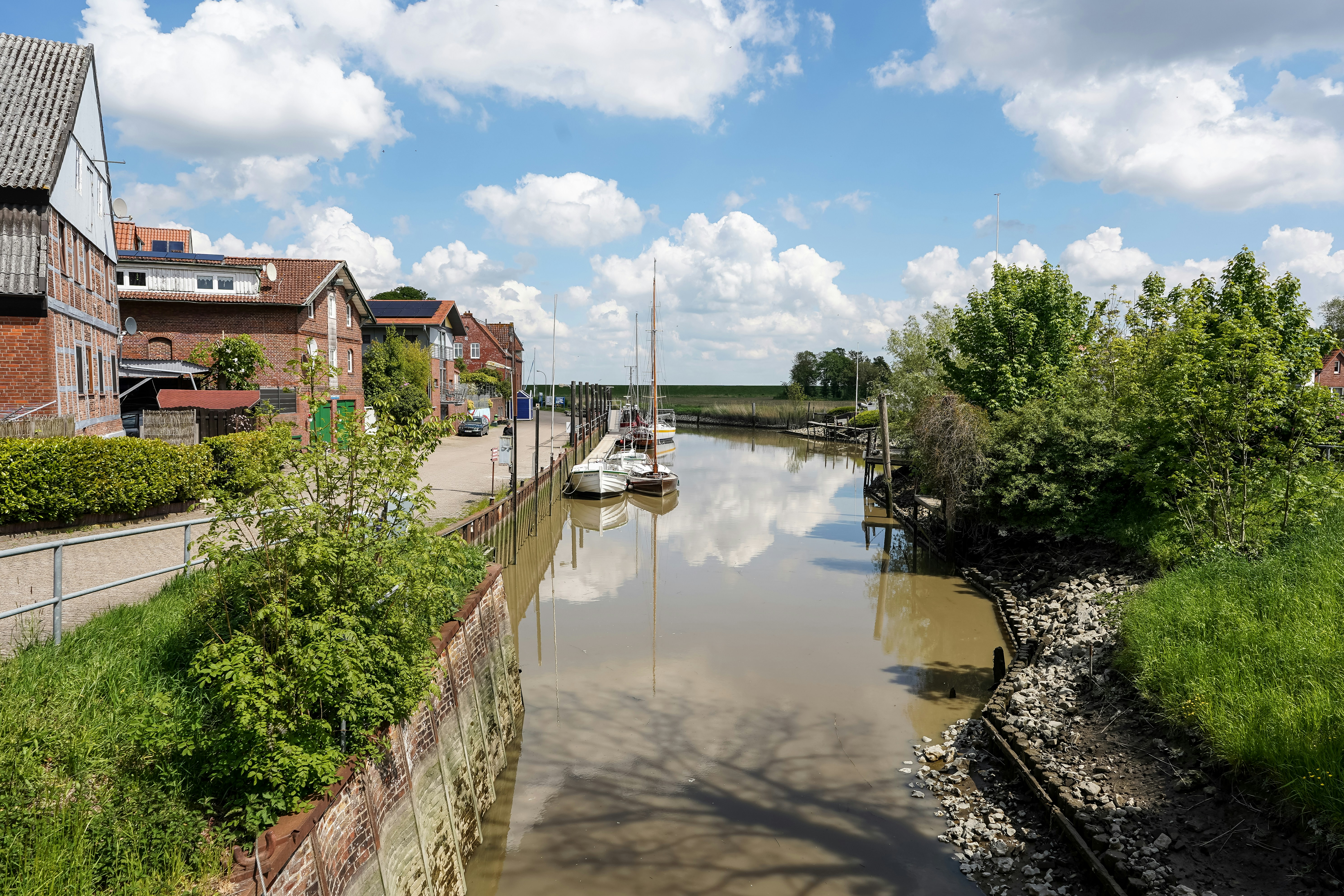 Canal Corridor: Boats, Brick Buildings, and a Broad Sky