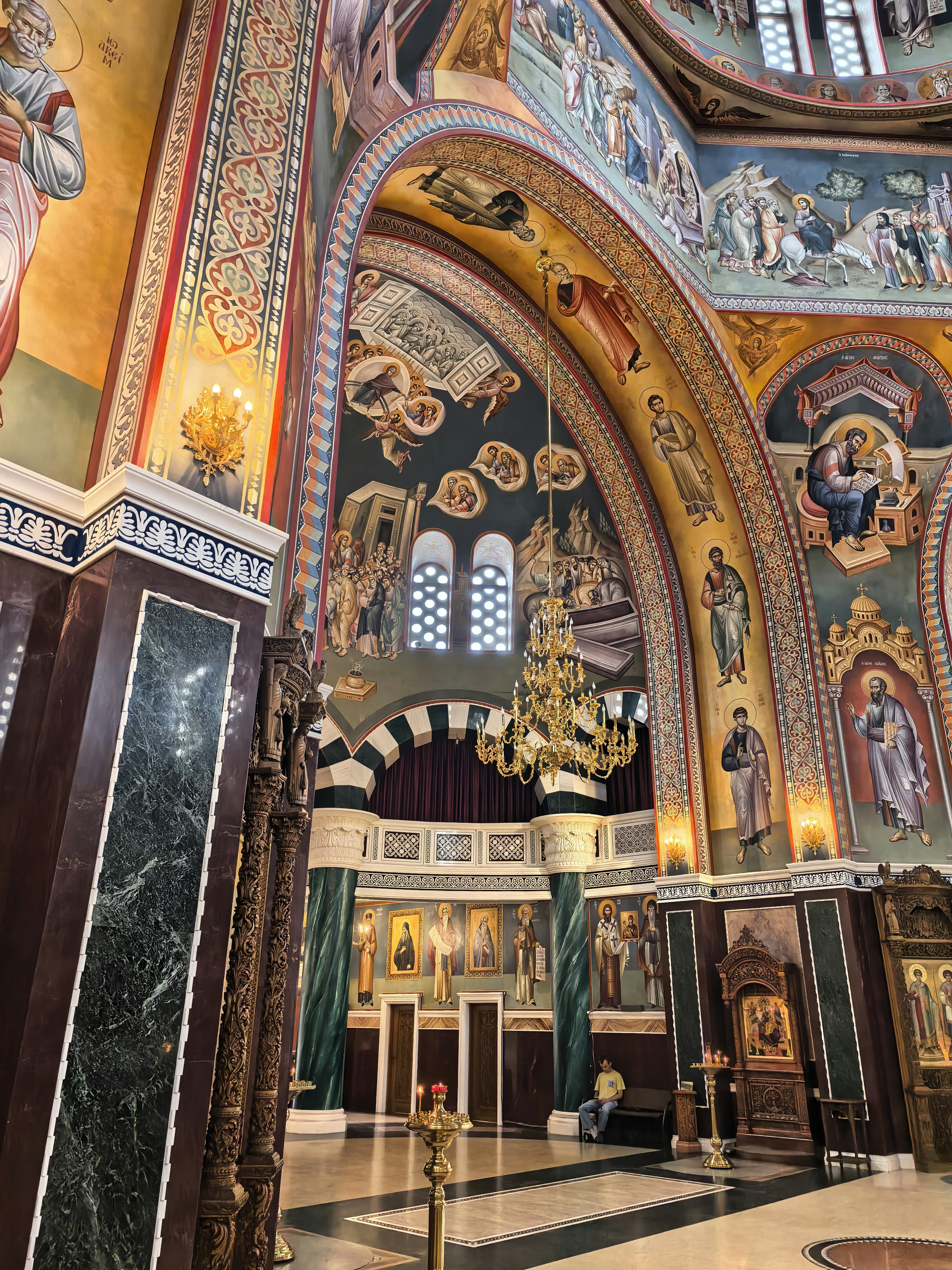 Church Interior: Archways, Mosaics, and Crystal Chandeliers