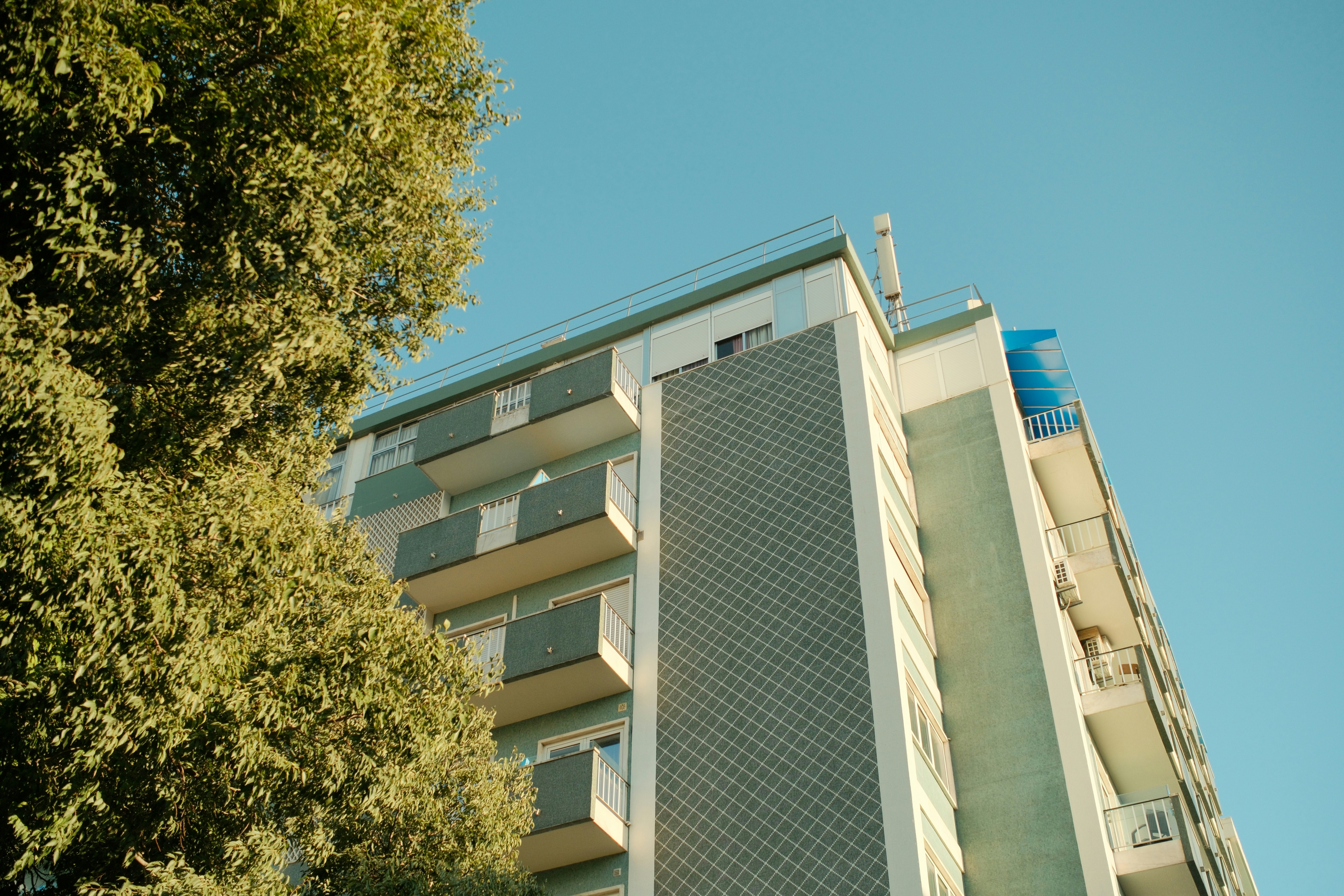 Sunlit Facade: A Modern Residential Tower Reaching Toward a Clear Sky