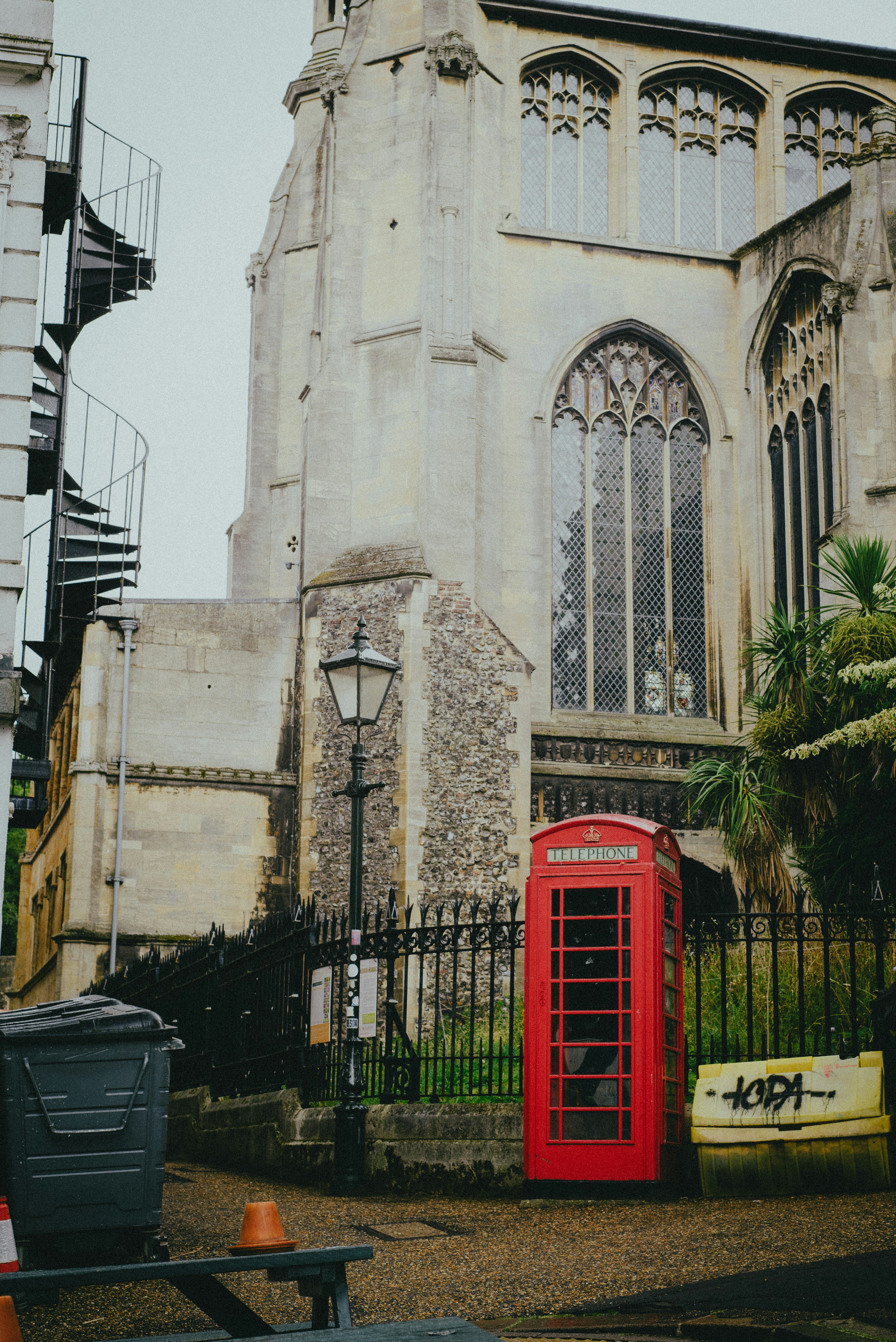 Red Telephone Box in a Historic Cathedral Courtyard