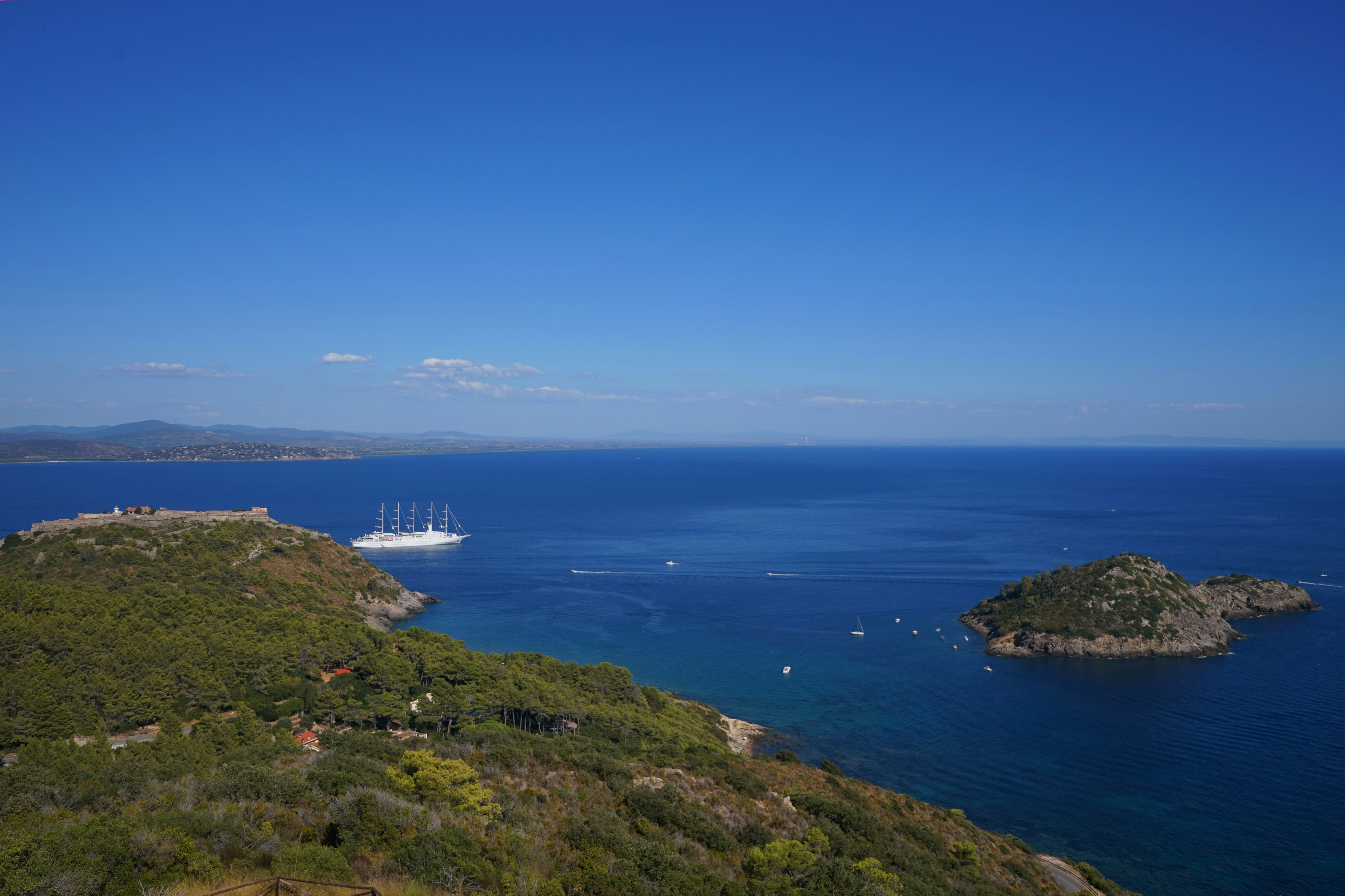 Cliffside Vista: Sailing Boats Adrift in a Serene Azure Bay
