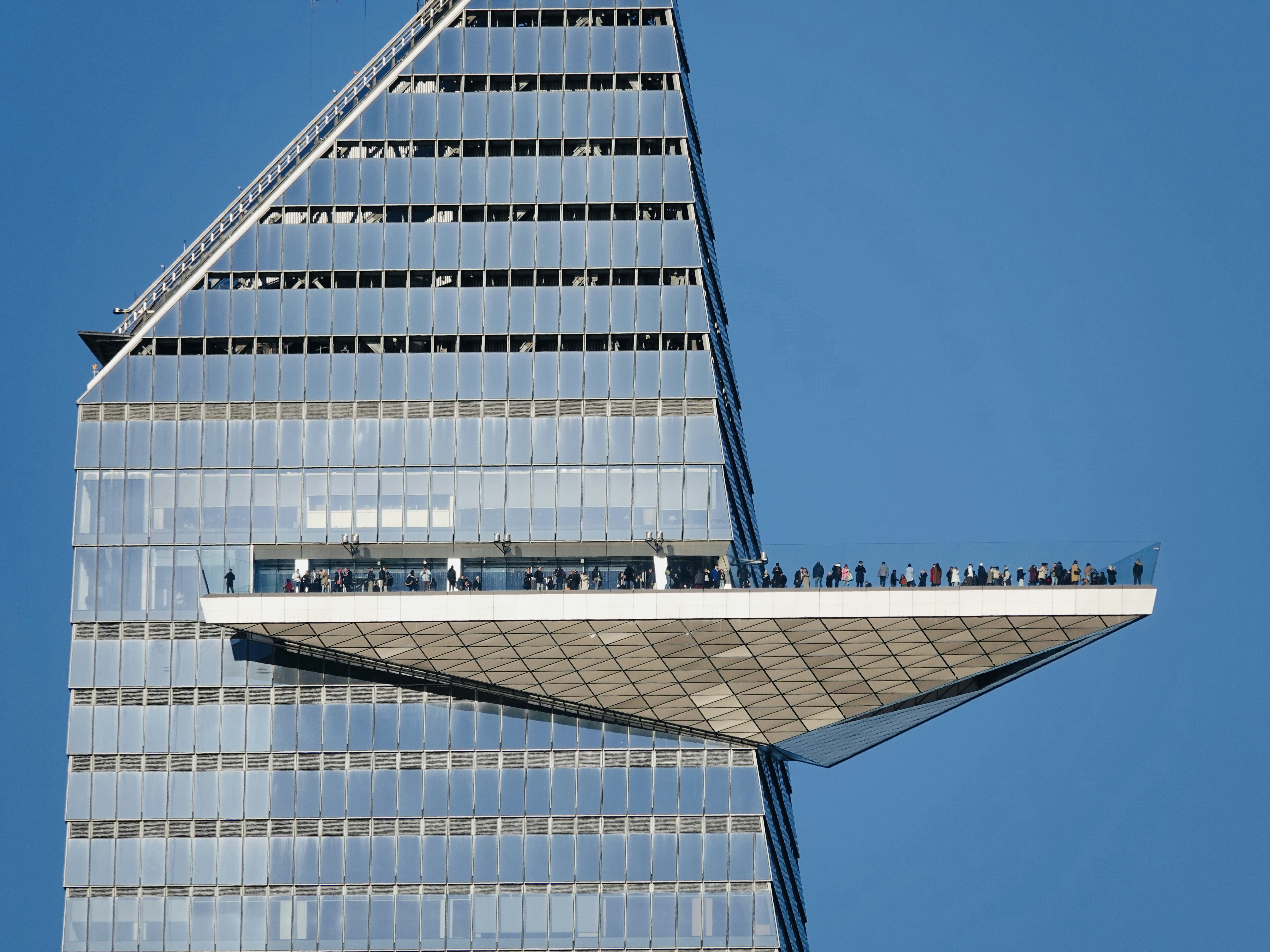 Skyward Terrace: Aerial View of a Lofty Glass Facade