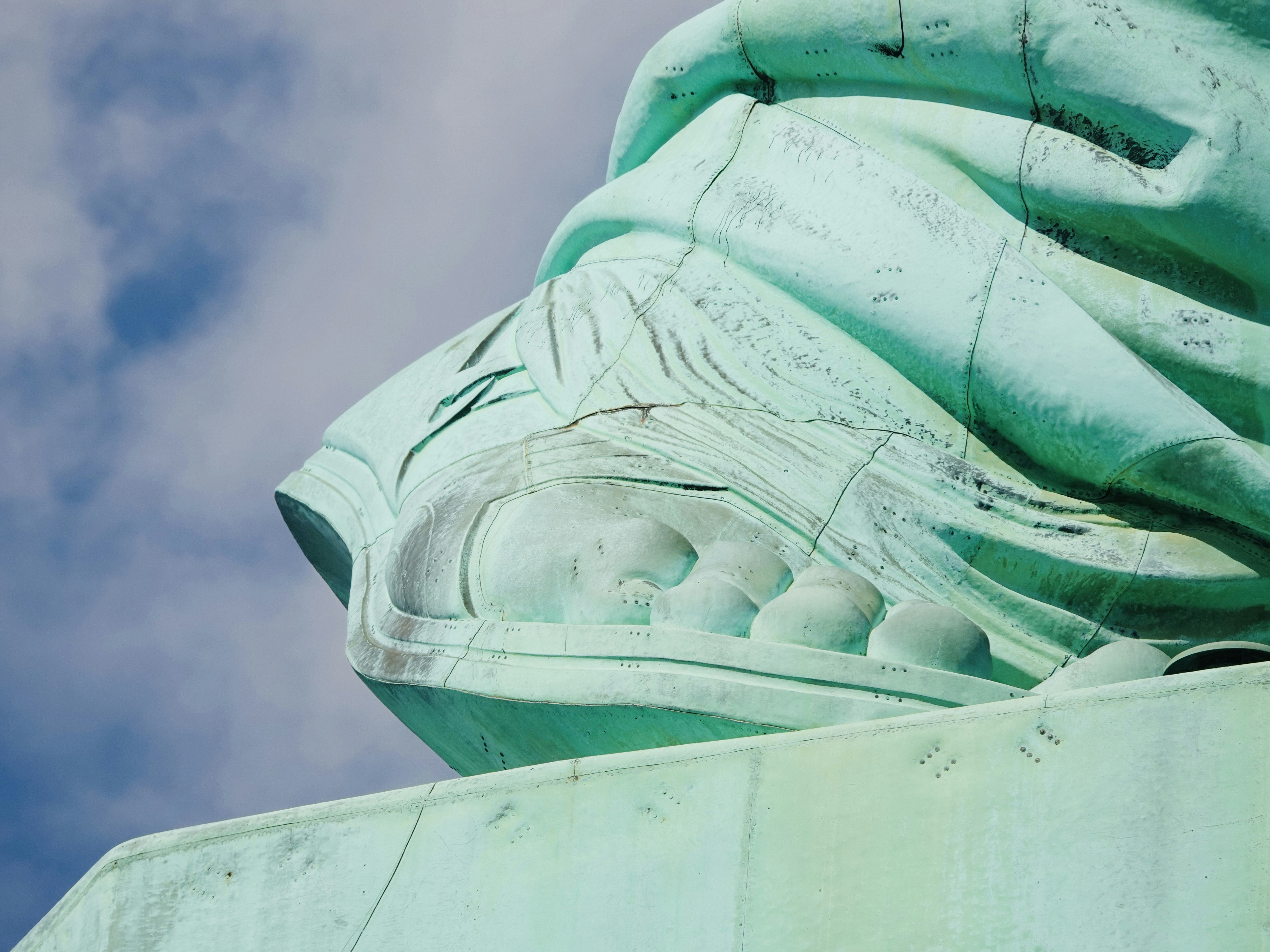 Vantage over the Feet: A Mint-Colored Statue's Modern Gaze