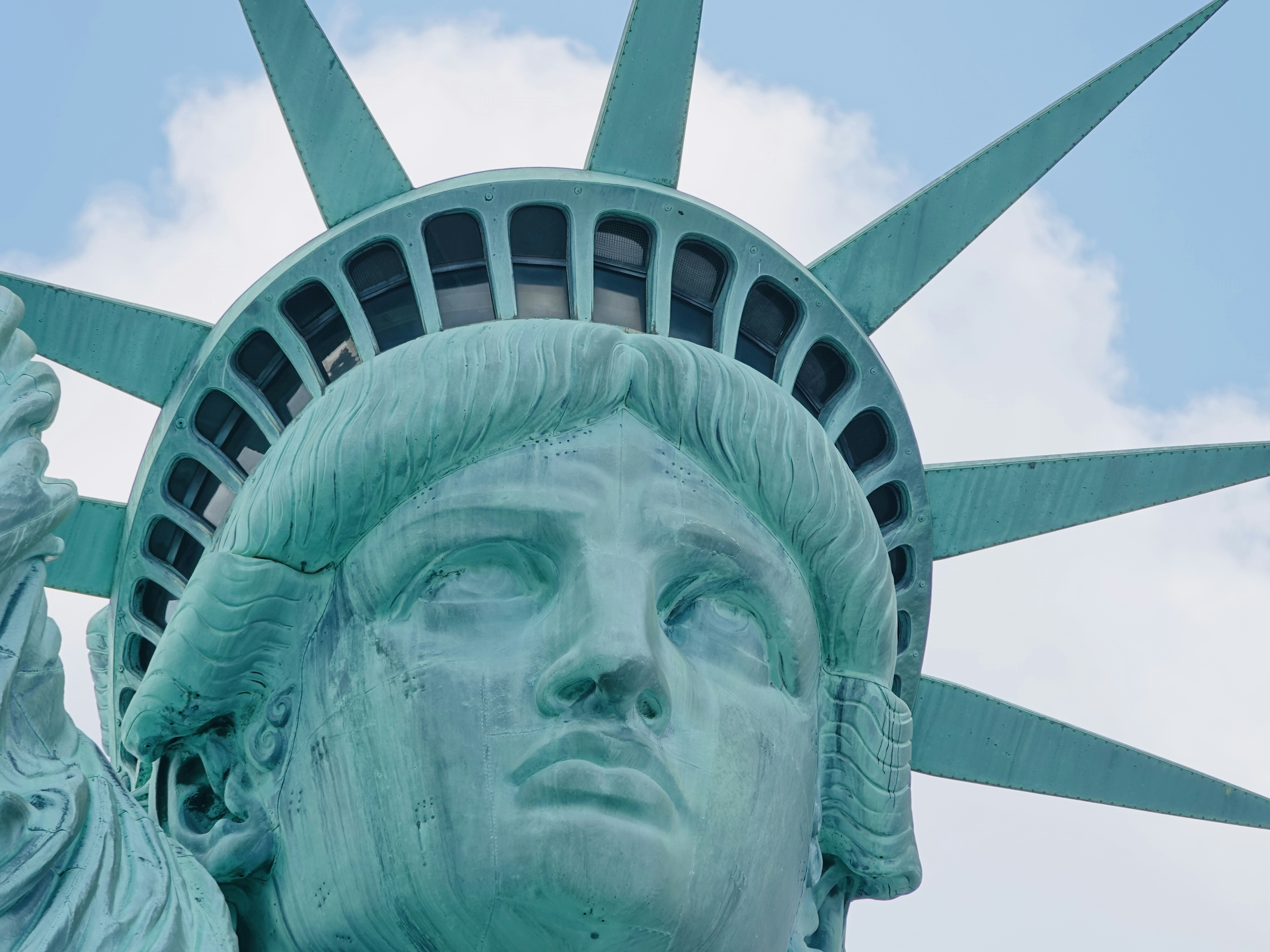 Coppered Gaze: The Statue of Liberty’s Face Under Sunlit Resolve