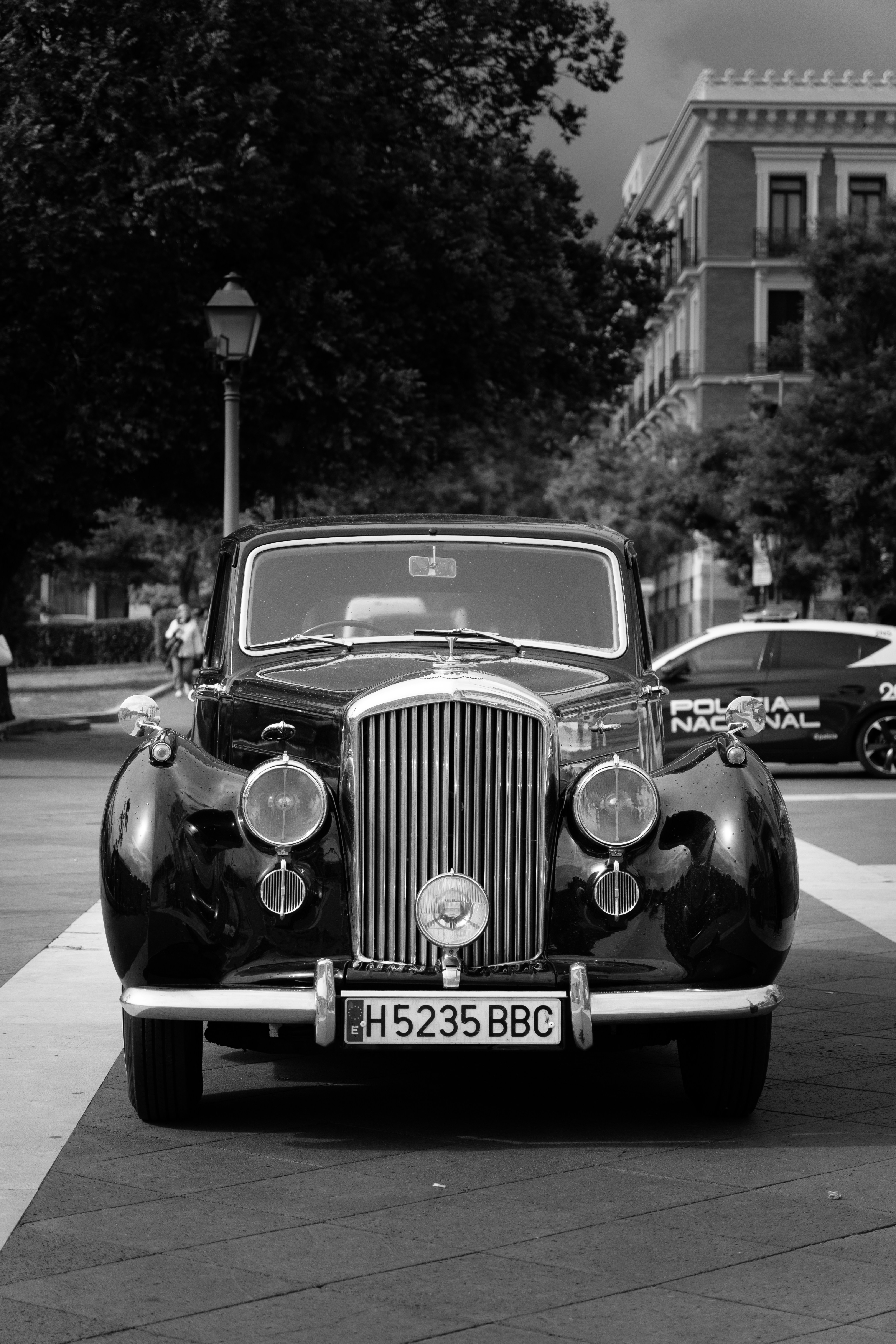 Front View of a Classic Black Vintage Car in an Urban Square