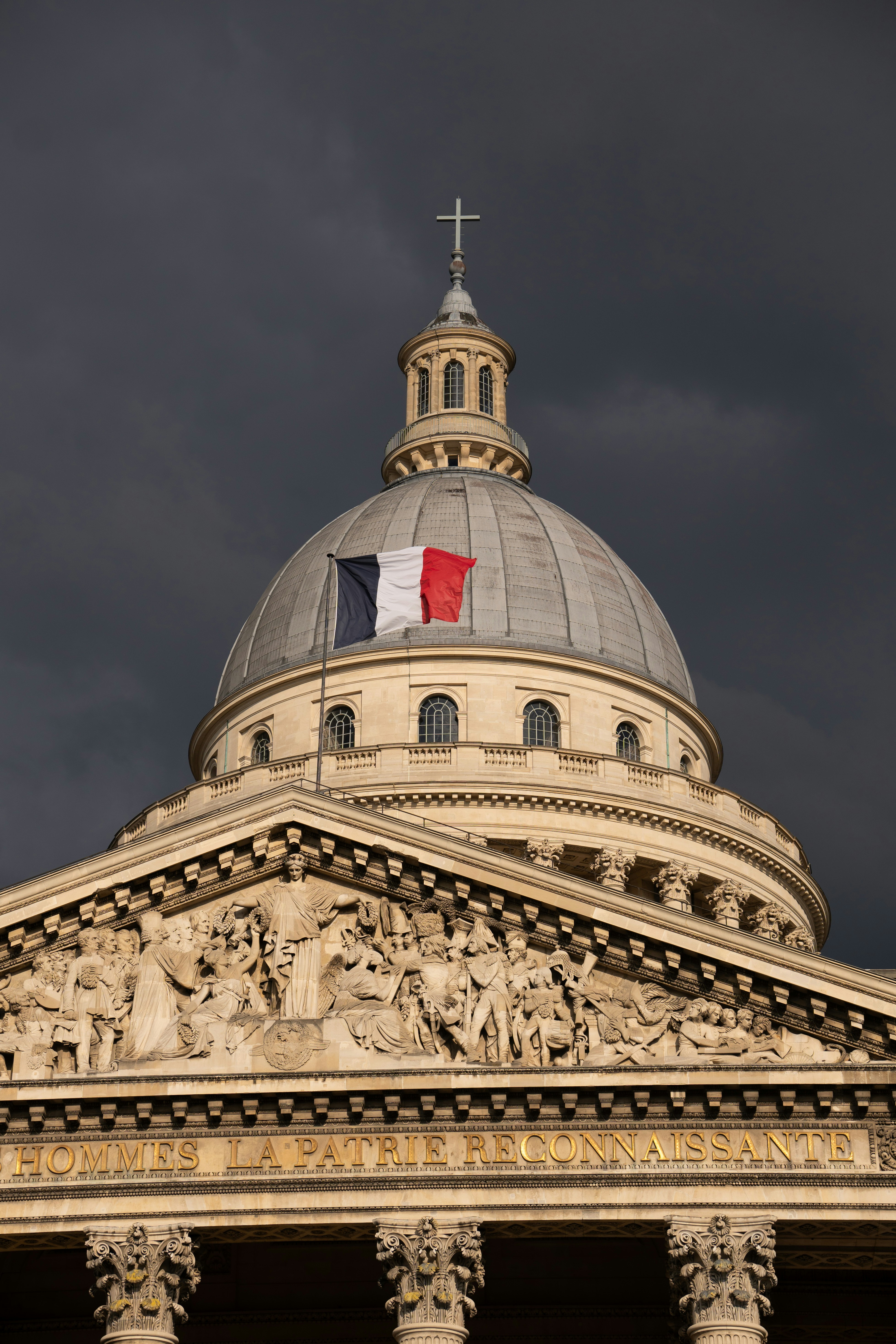 Flag on the Dome: A Classic French National Crest Against Stormy Skies