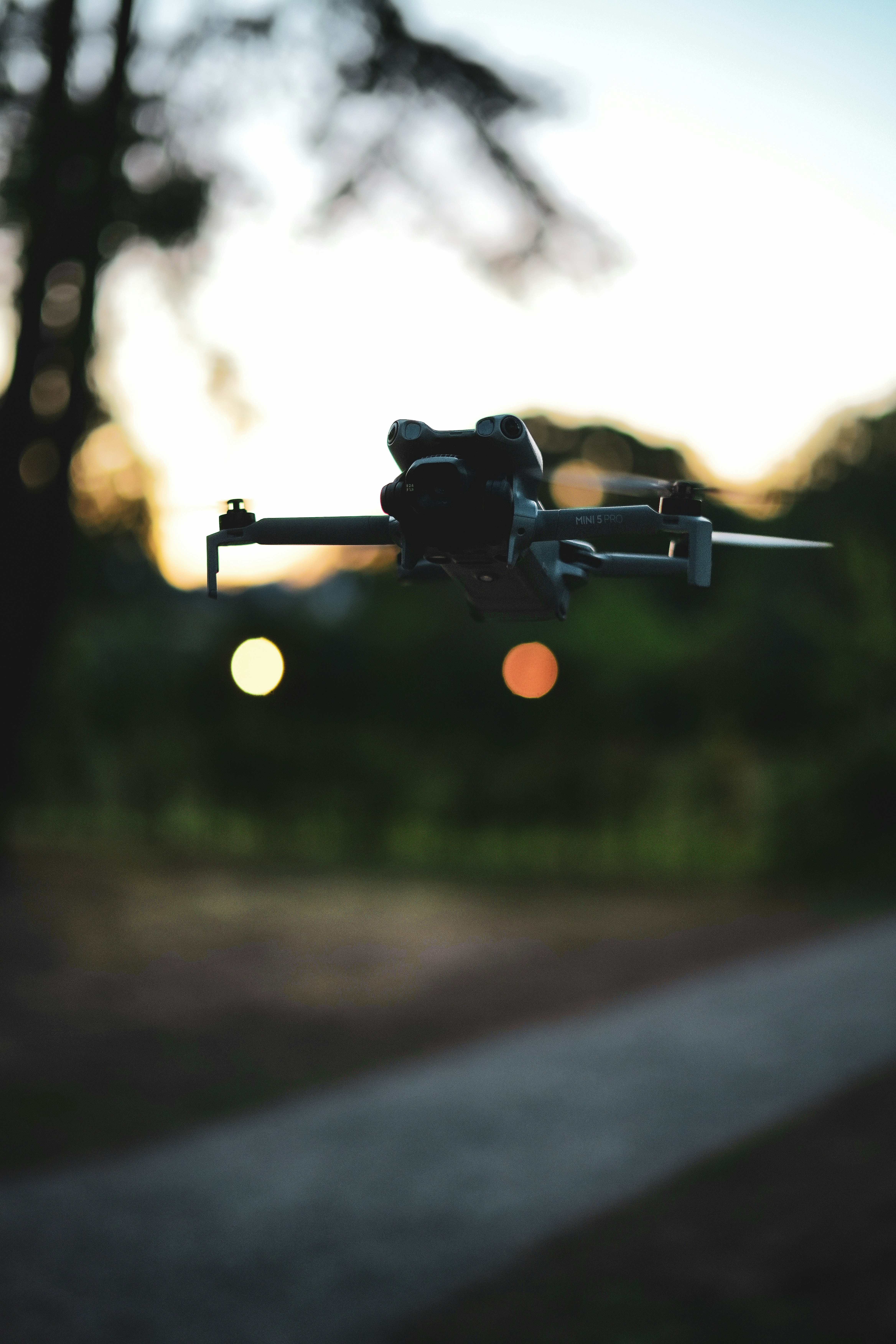 Hovering Drone at Dusk: A Quiet Moment Above a Park Path