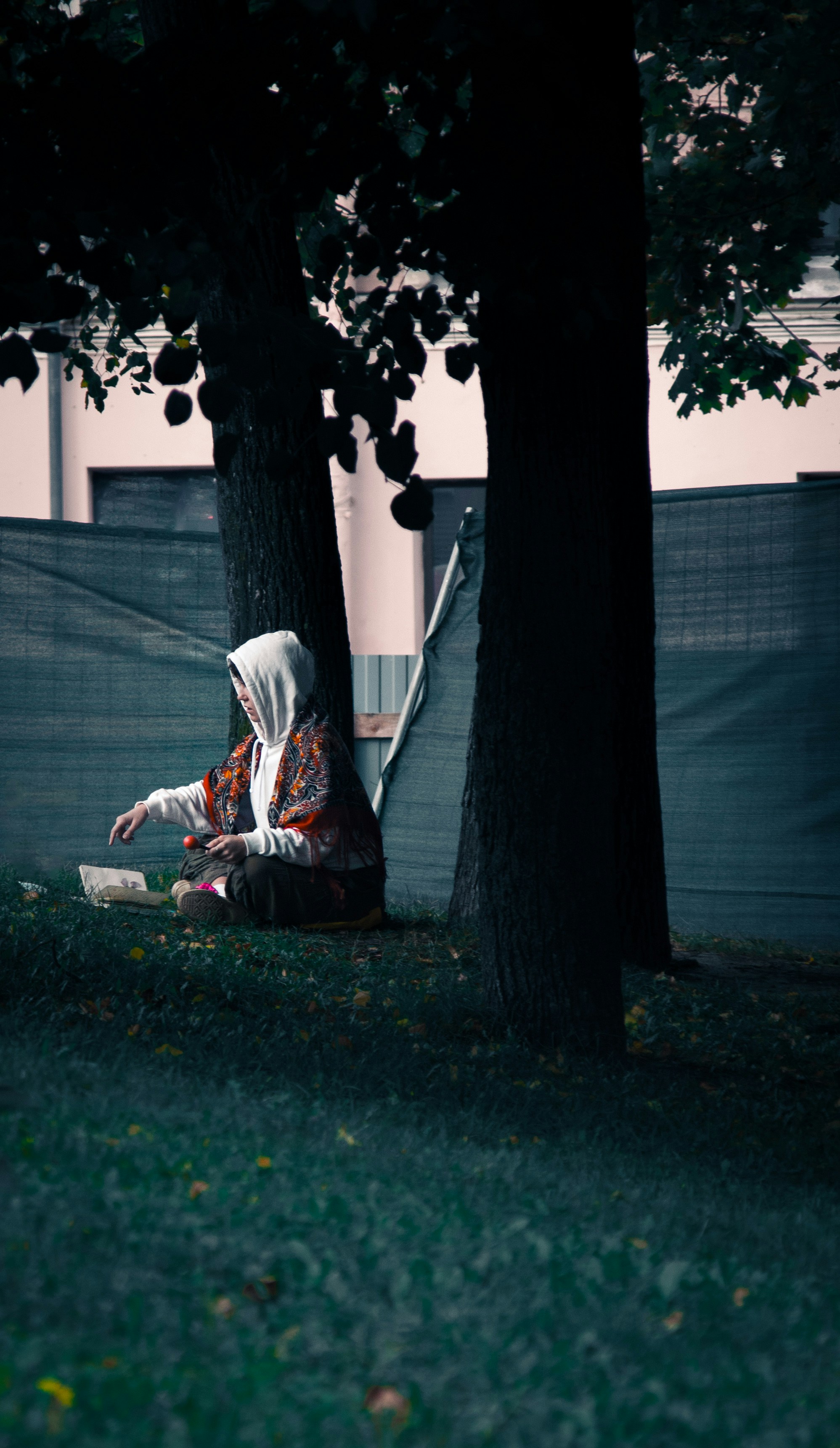Hidden Listener in the Park: A Cloaked Figure by the Fence