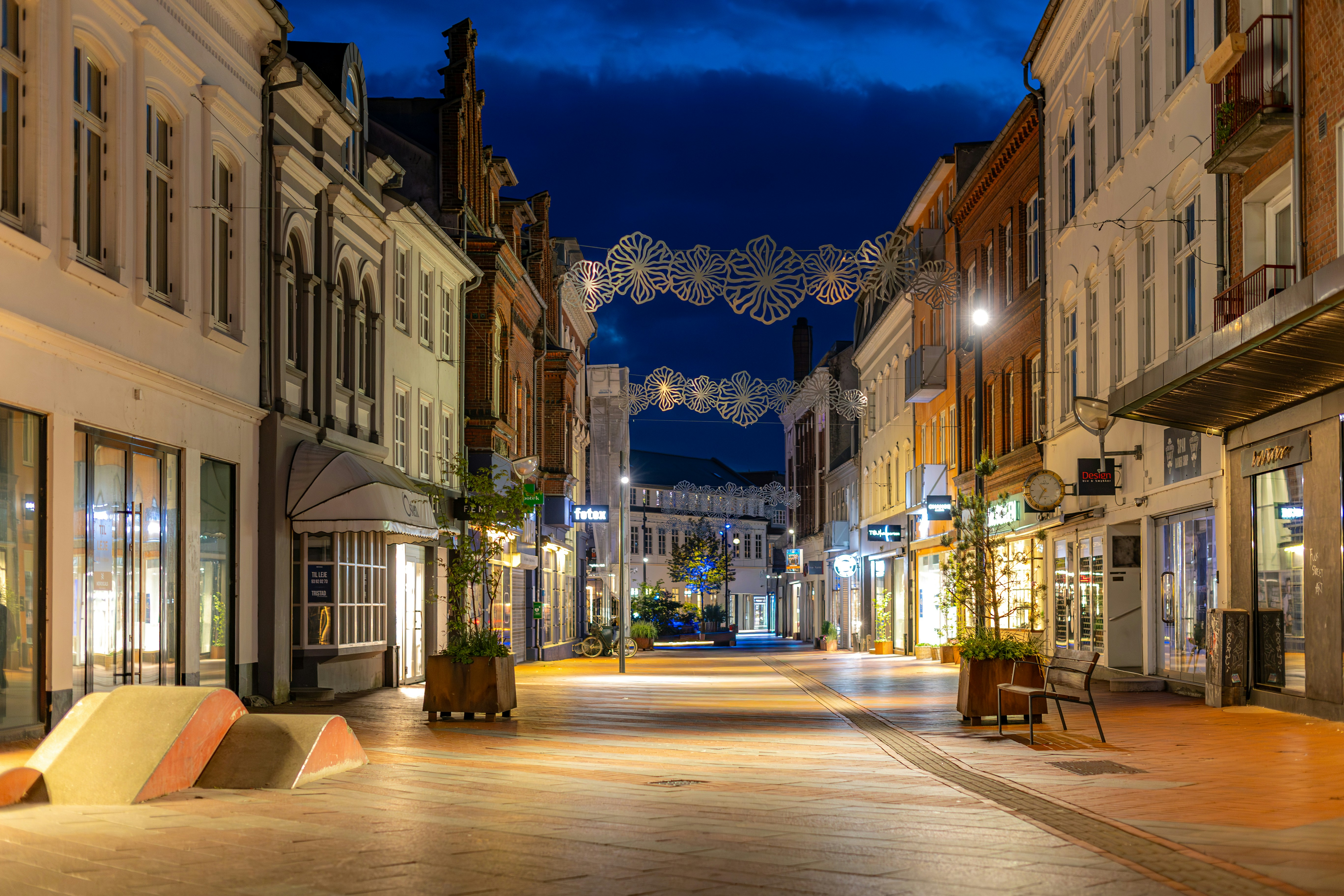 Nightfall in a quaint illuminated pedestrian street