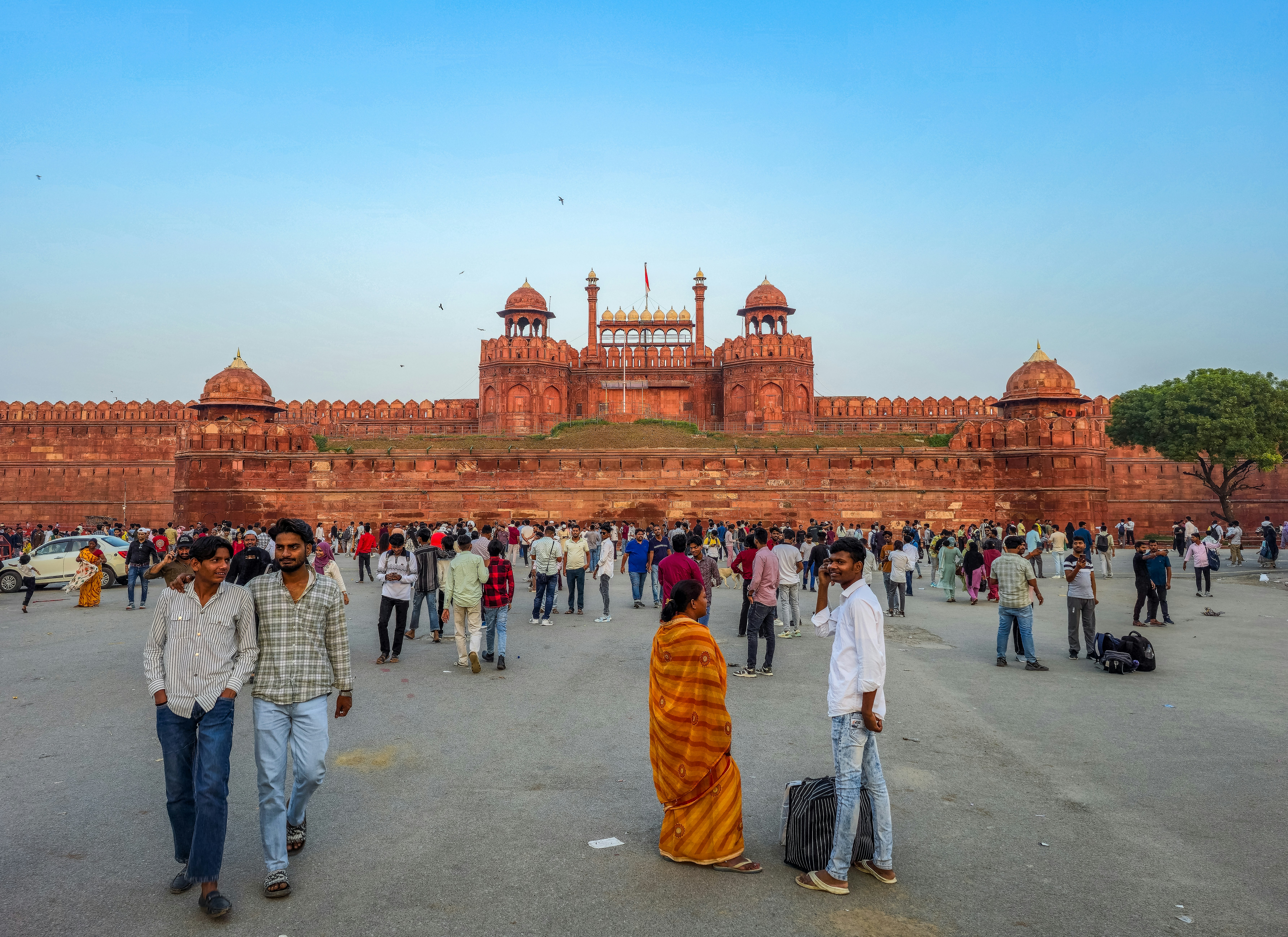 Red Fort at dusk: a bustling courtyard beneath ceremonial gates