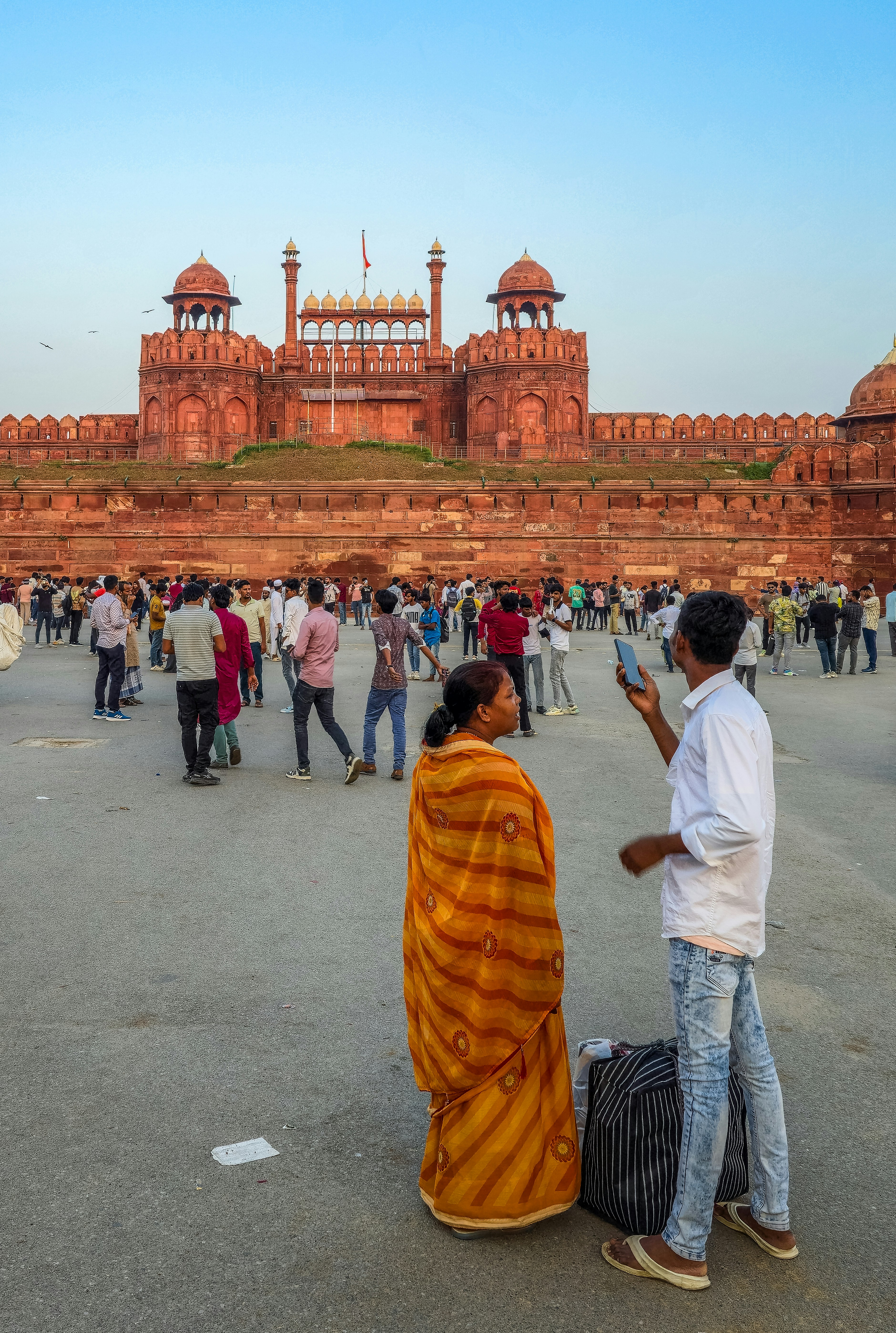 Duet at the Gate: A couple in front of the red sandstone fortress