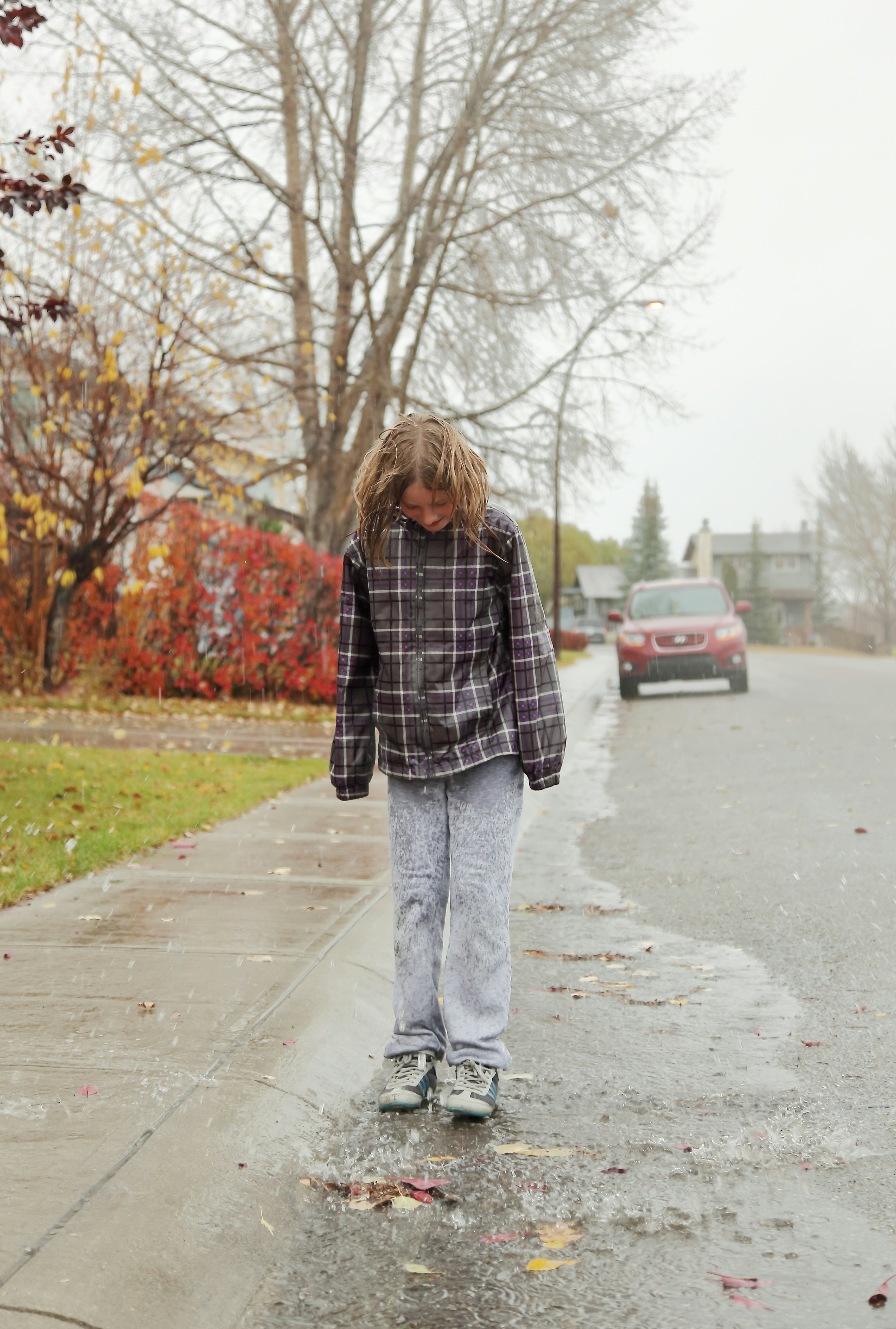 Lonely Walk: A Youth Traveler on a Rainy Autumn Street