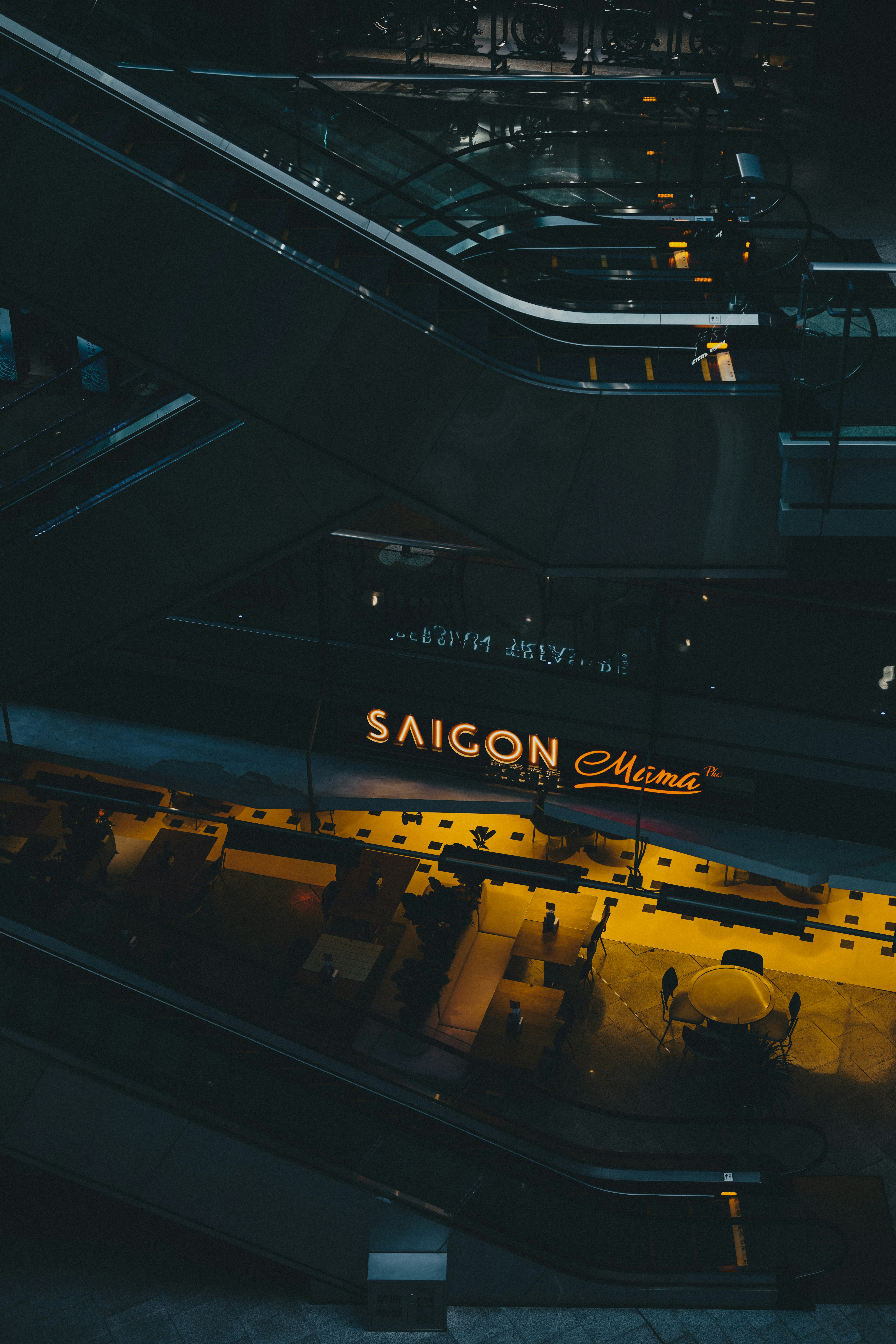 Neon Saigon at Dusk: A Quiet Convergence of Escalators and Warm Light
