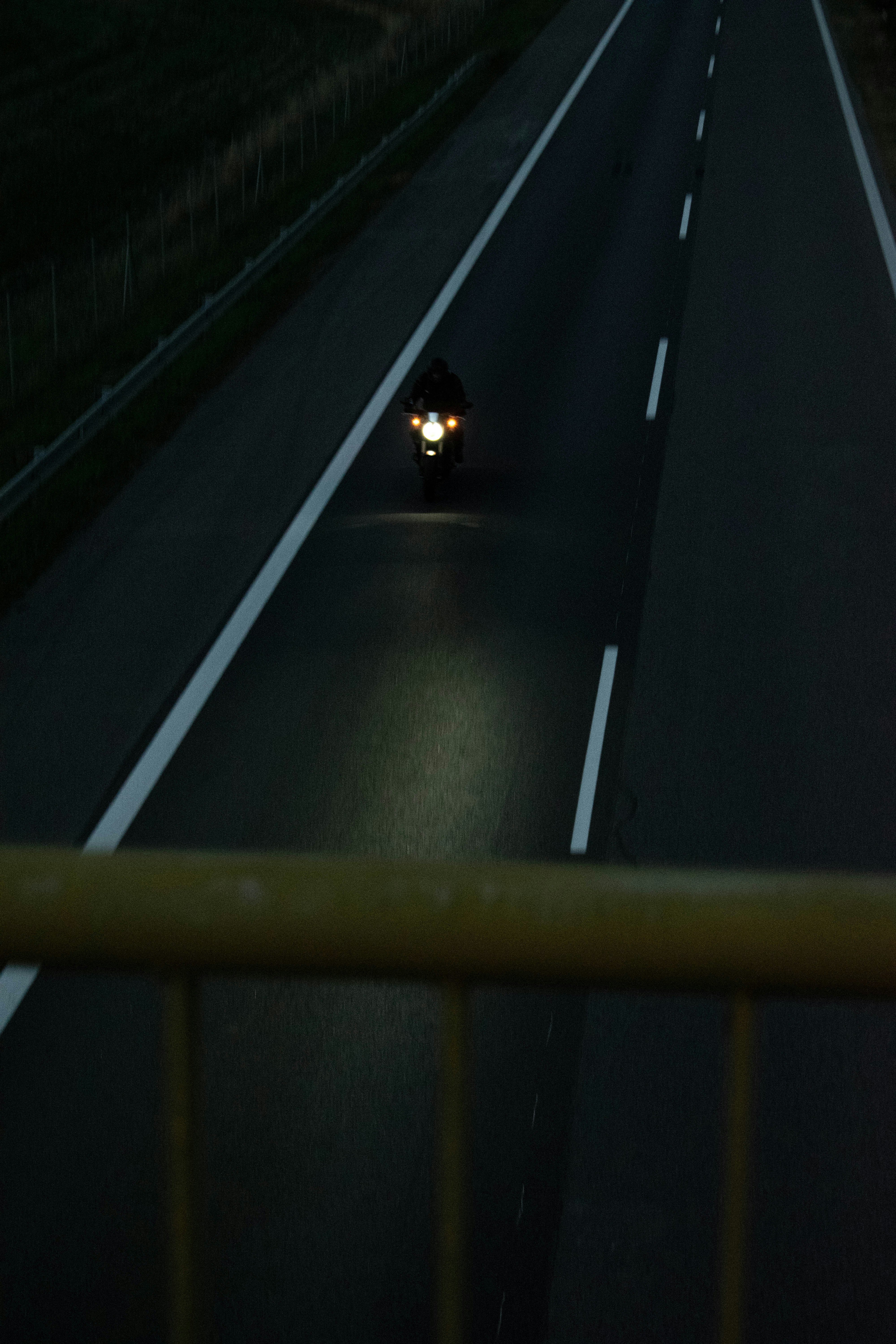 Midnight Ride: A lone motorcycle lights the empty highway