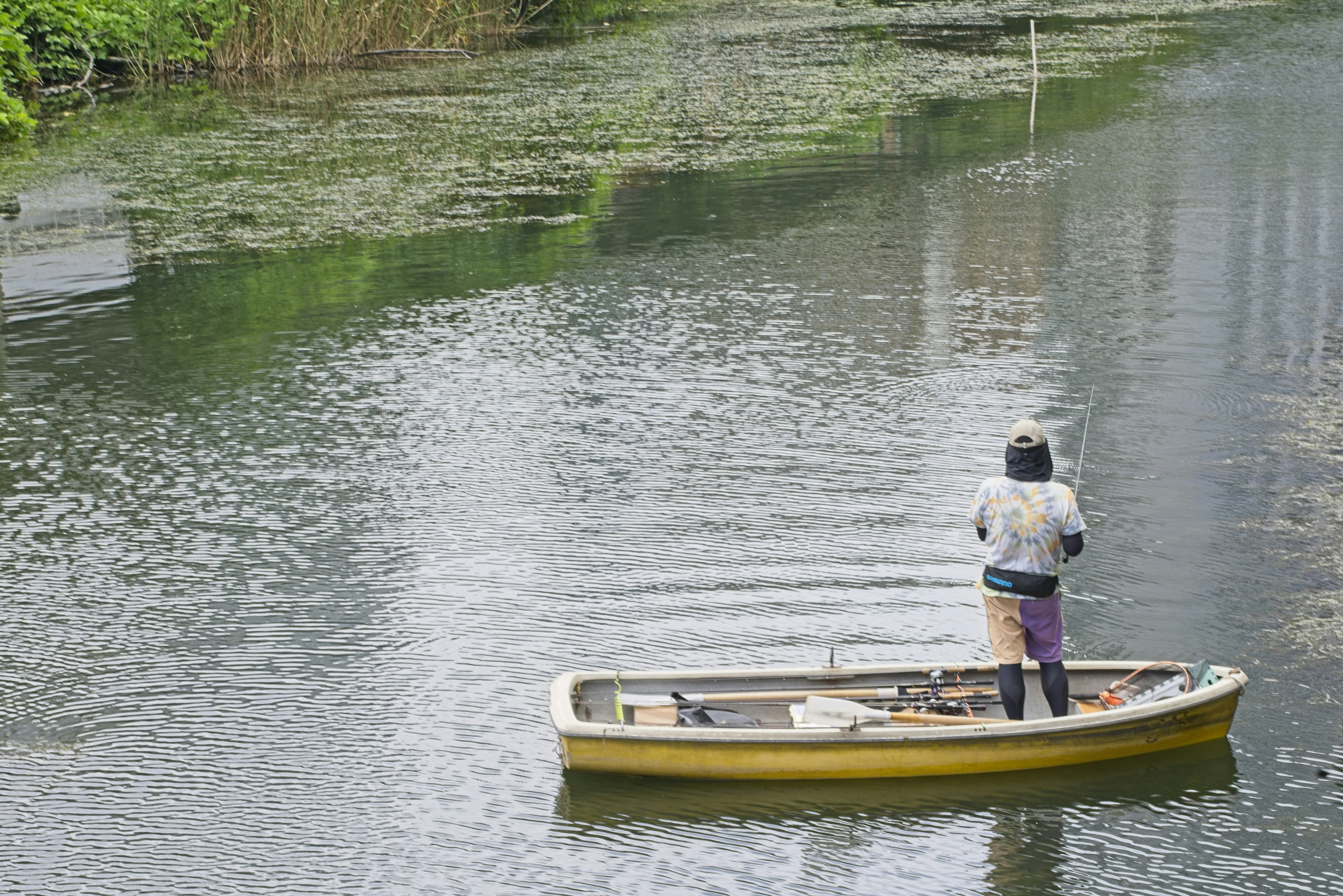 Angler in a Yellow Boat: Quiet Riverscape with a Lone Fisherman