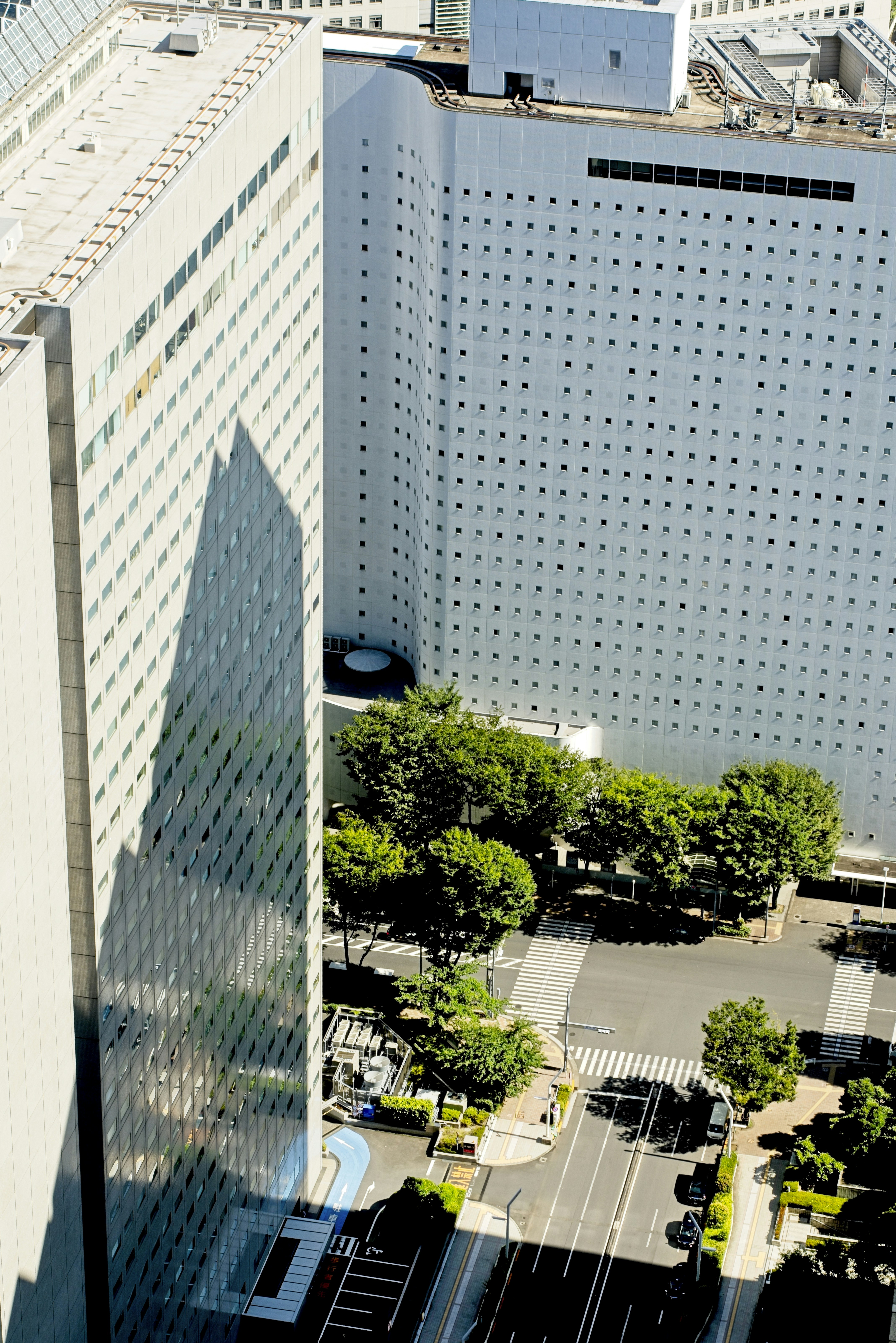 Aerial Glide Over City Grid Between Glass Facades