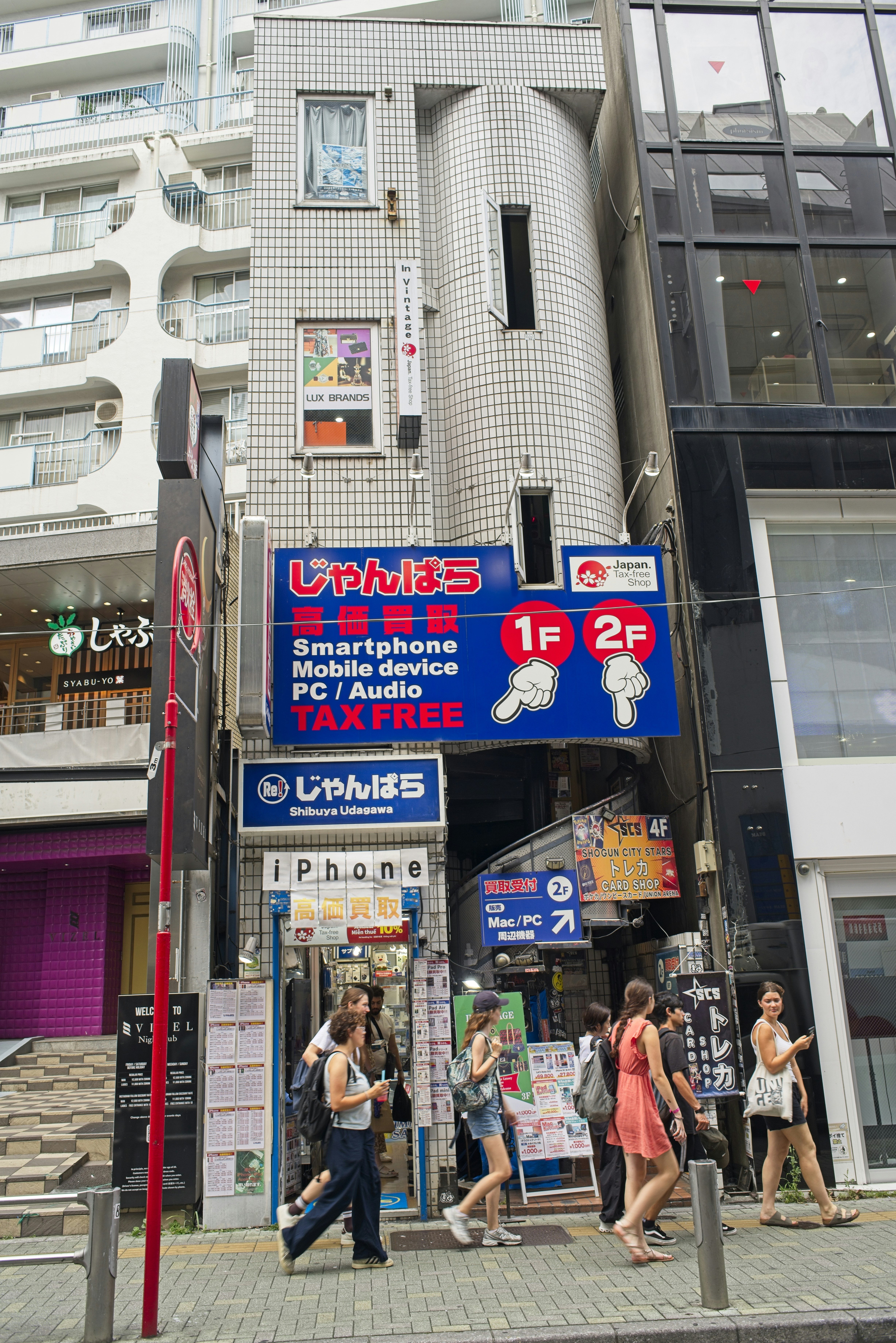 City Signboard Cascade: Japanese Street Scene with Tech Shops