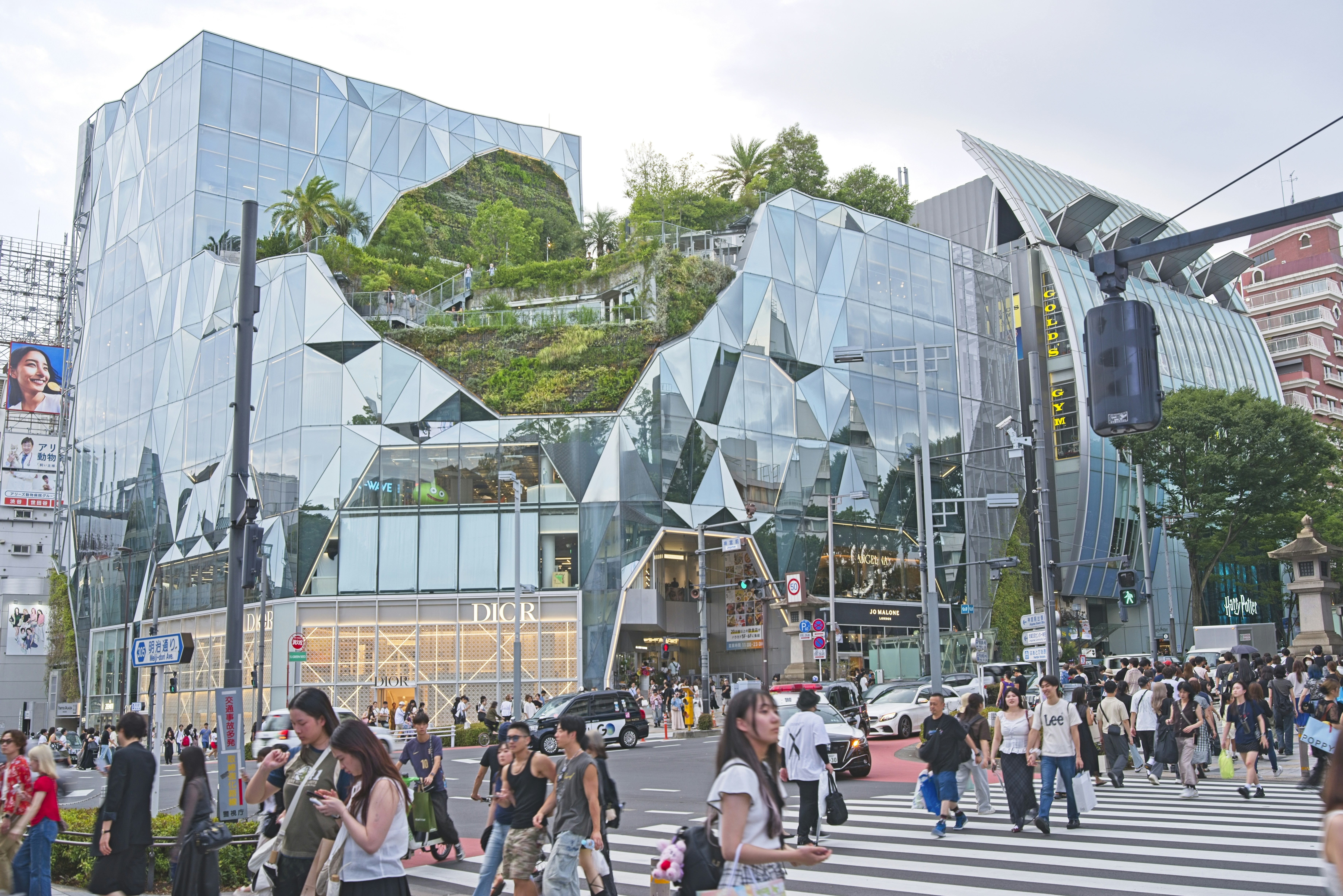Geometric Glass Facade Meets City Pulse at Shibuya Crossing-like Footbridge