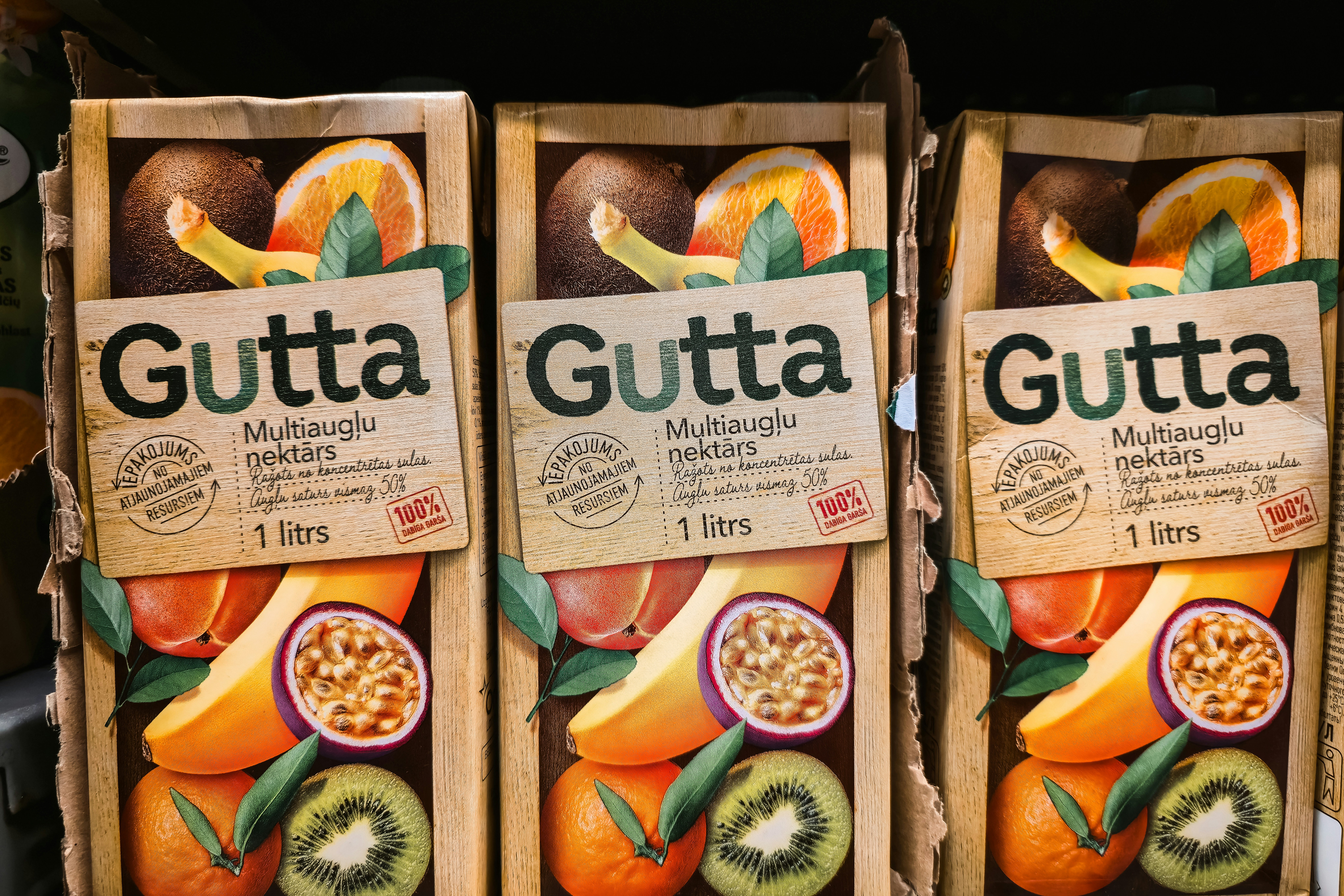 Stacked Gutta Juice Cartons: Bright Labels and Juicy Fruits on Display