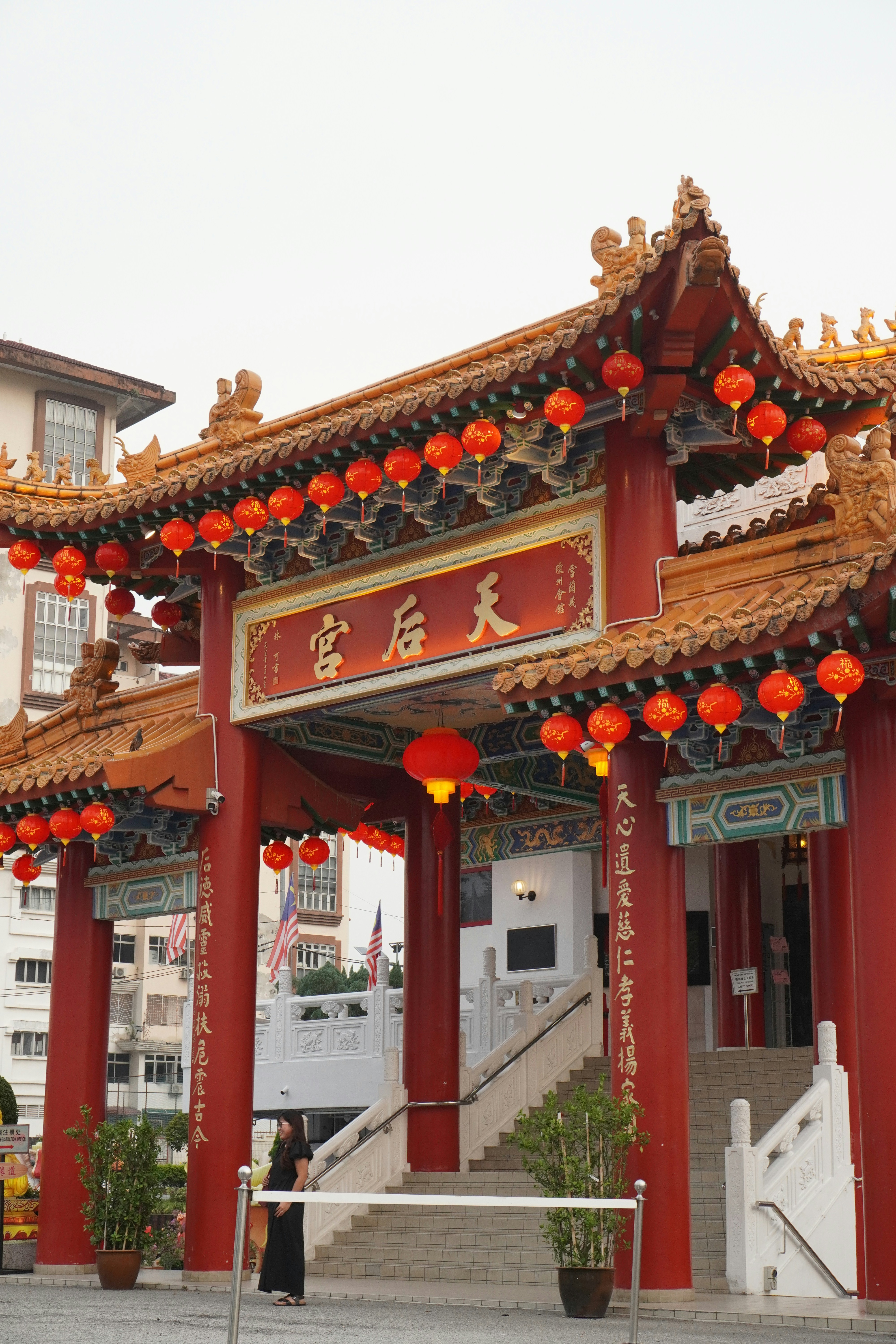 Gateway of Lanterns: A Red Archway Adorned with Fireworks and Chinese Characters
