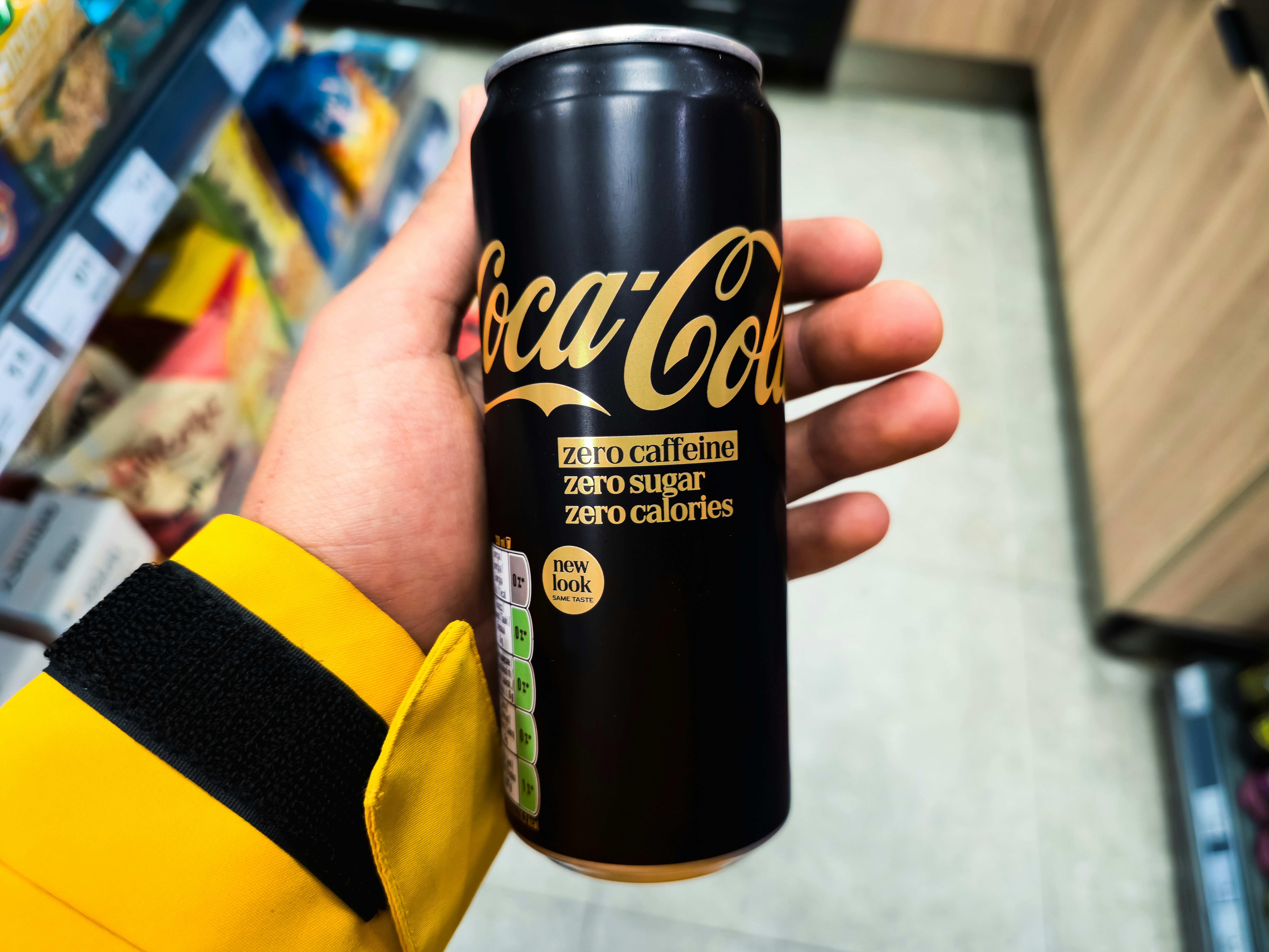 Coca-Cola Can in Hand: A Quiet Aisle Moment
