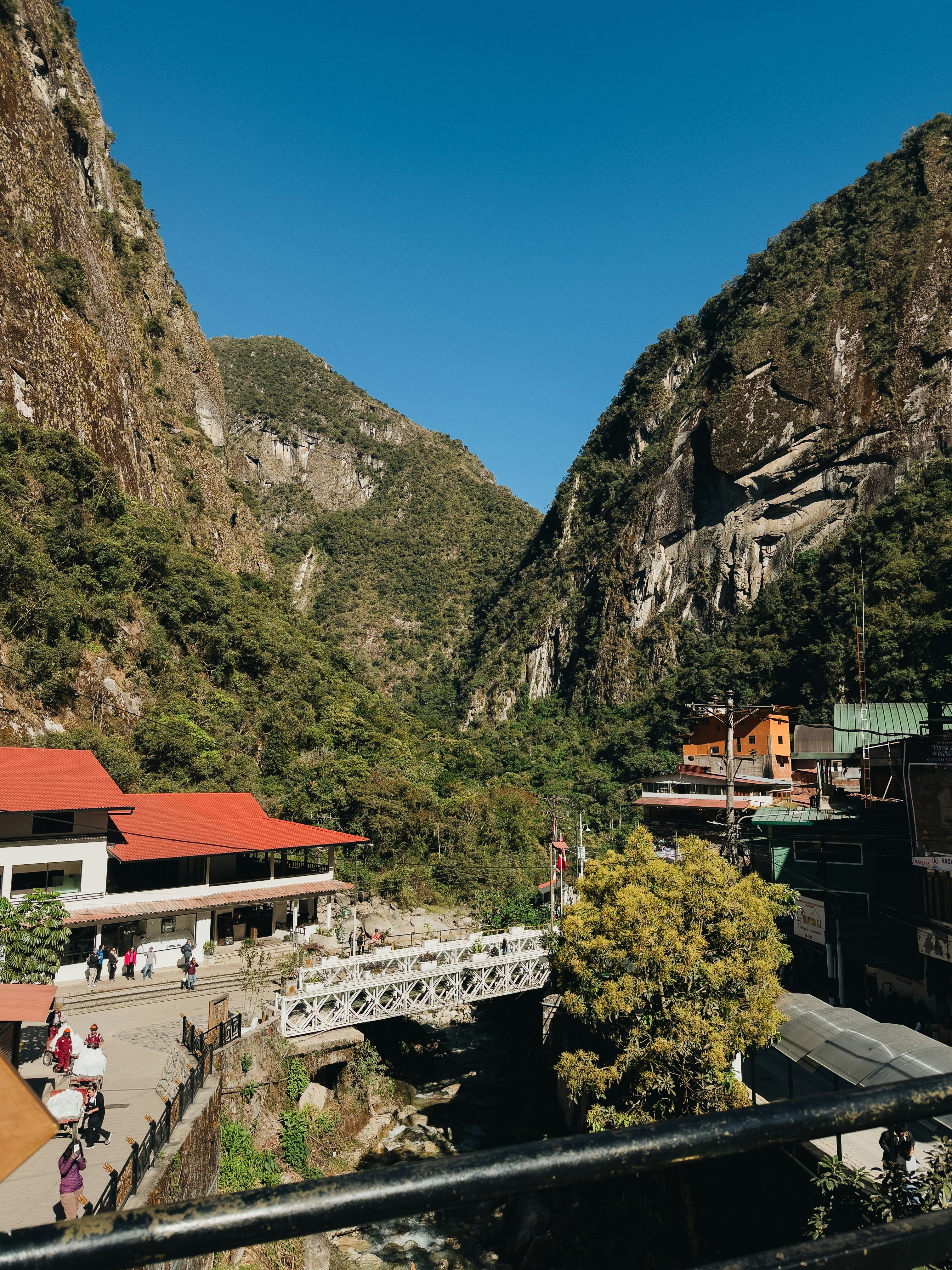 Riverside village tucked between towering gorge walls