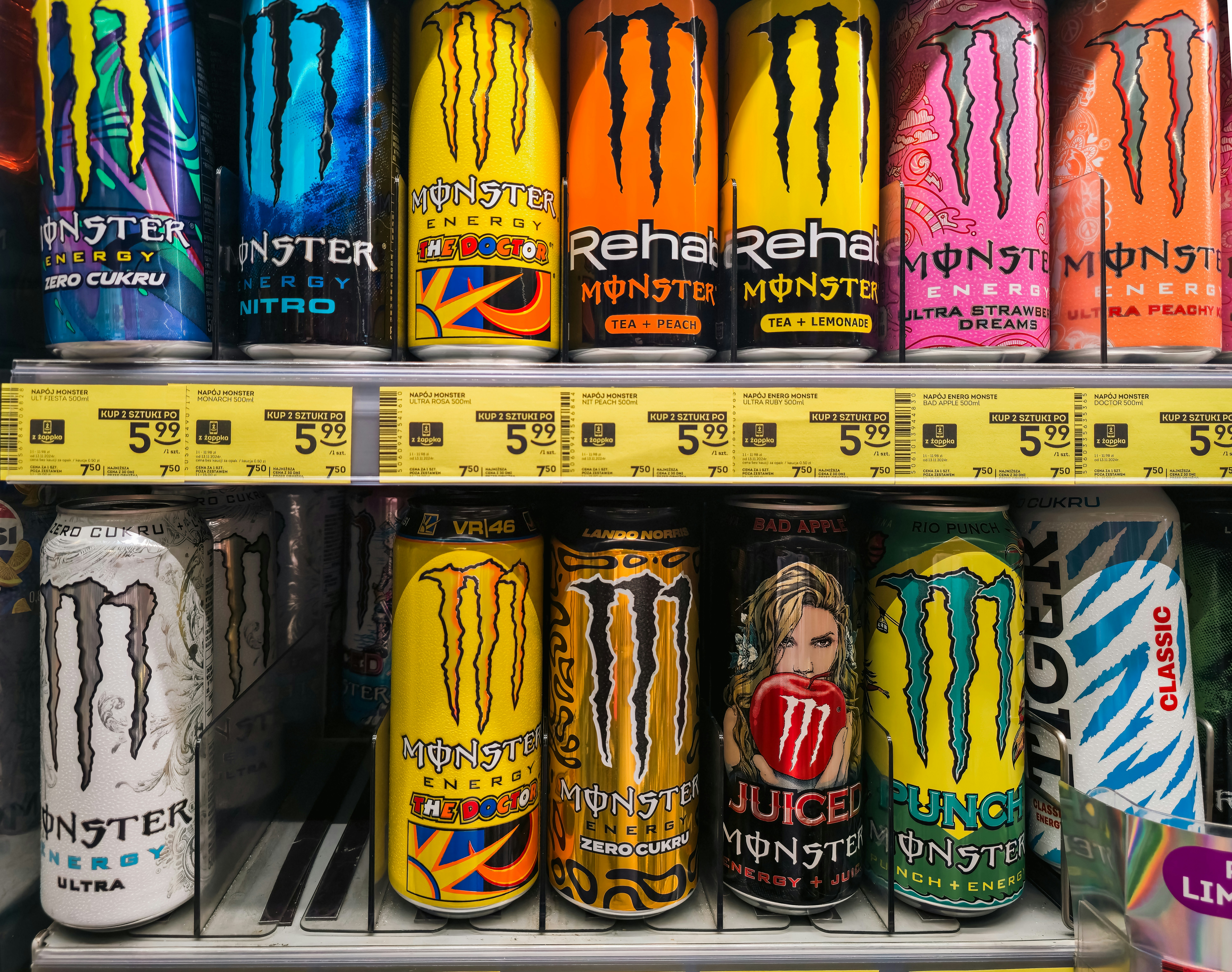 Caffeinated Spectrum: Monster Energy Cans in a Colorful Aisle
