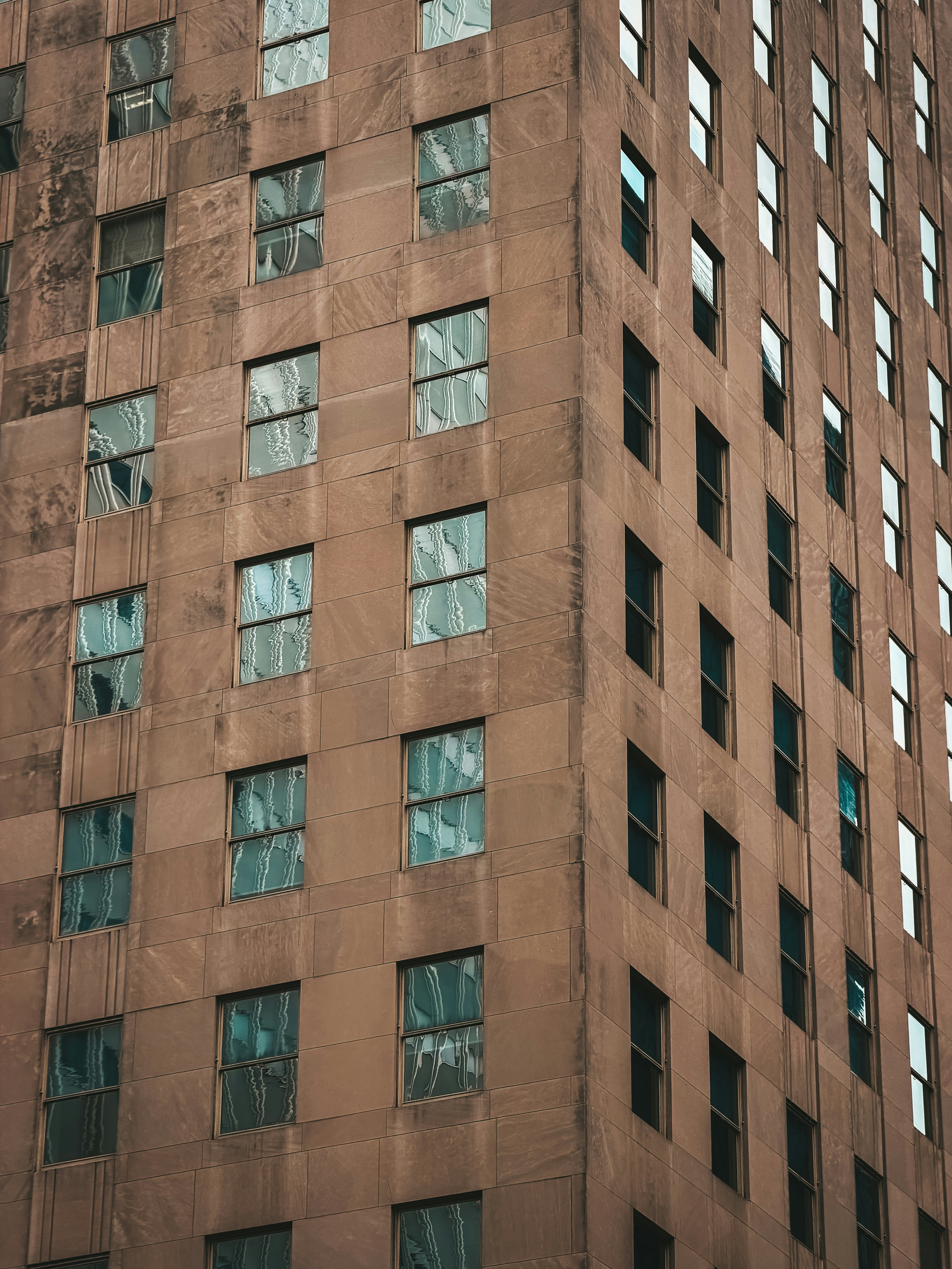 Grid of Windows on a Weathered Building Facade