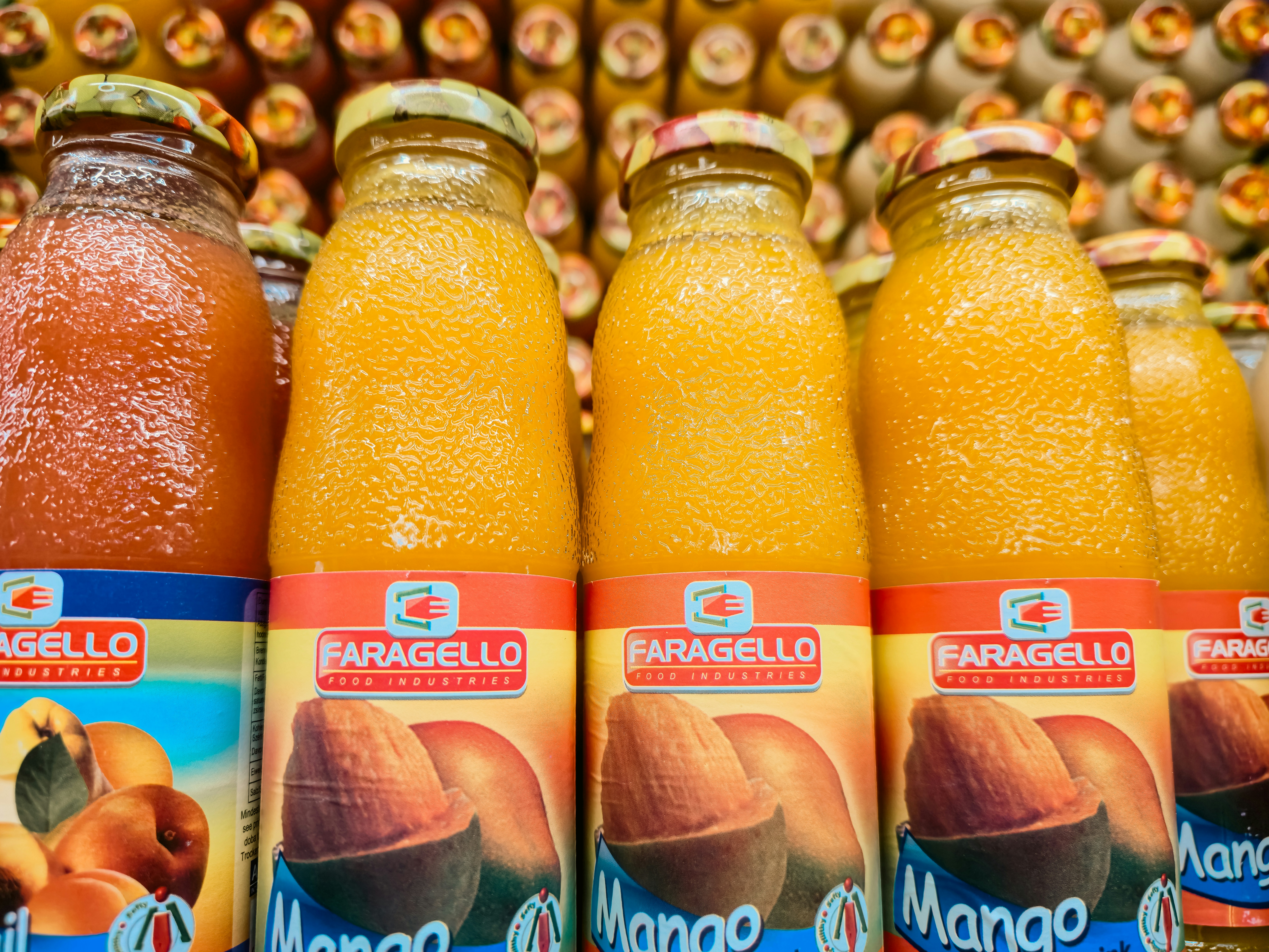 Bright Mangoes in Row: Juicy Bottles Stand at Attention