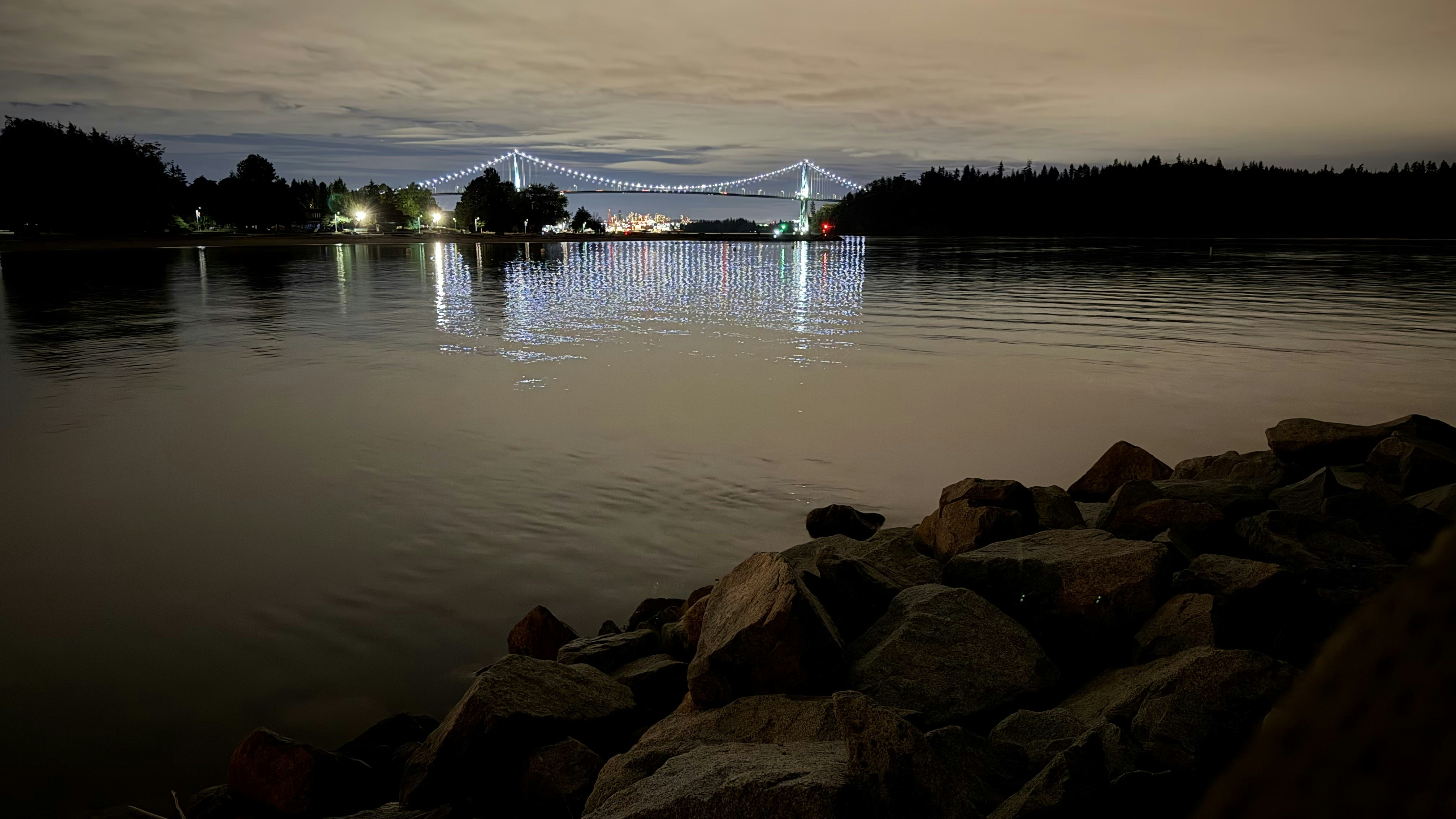 Evening Lights on the River: Bridge Glow and Calm Ripples