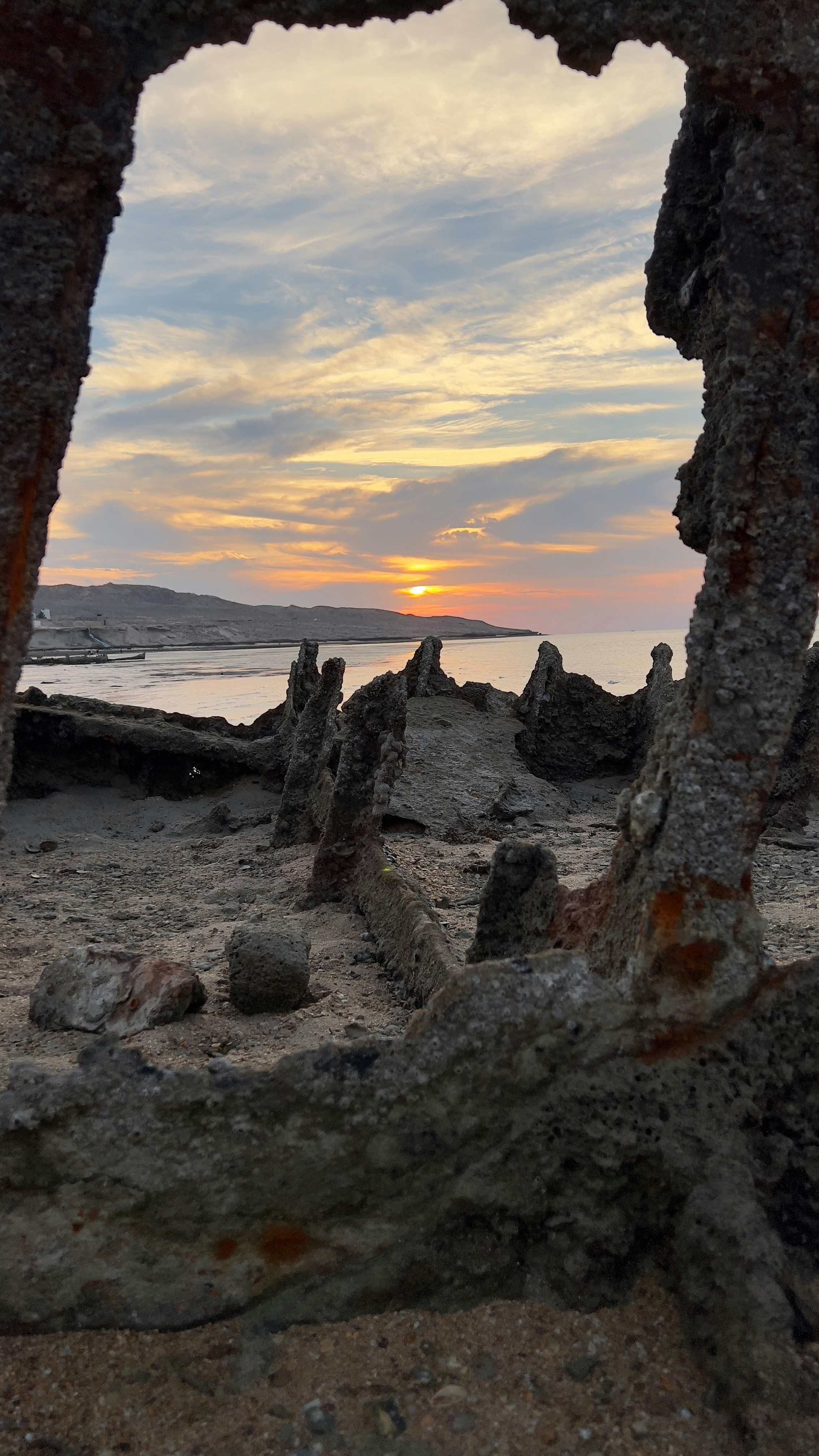 Sunset Through a Fractured Arch of Stone