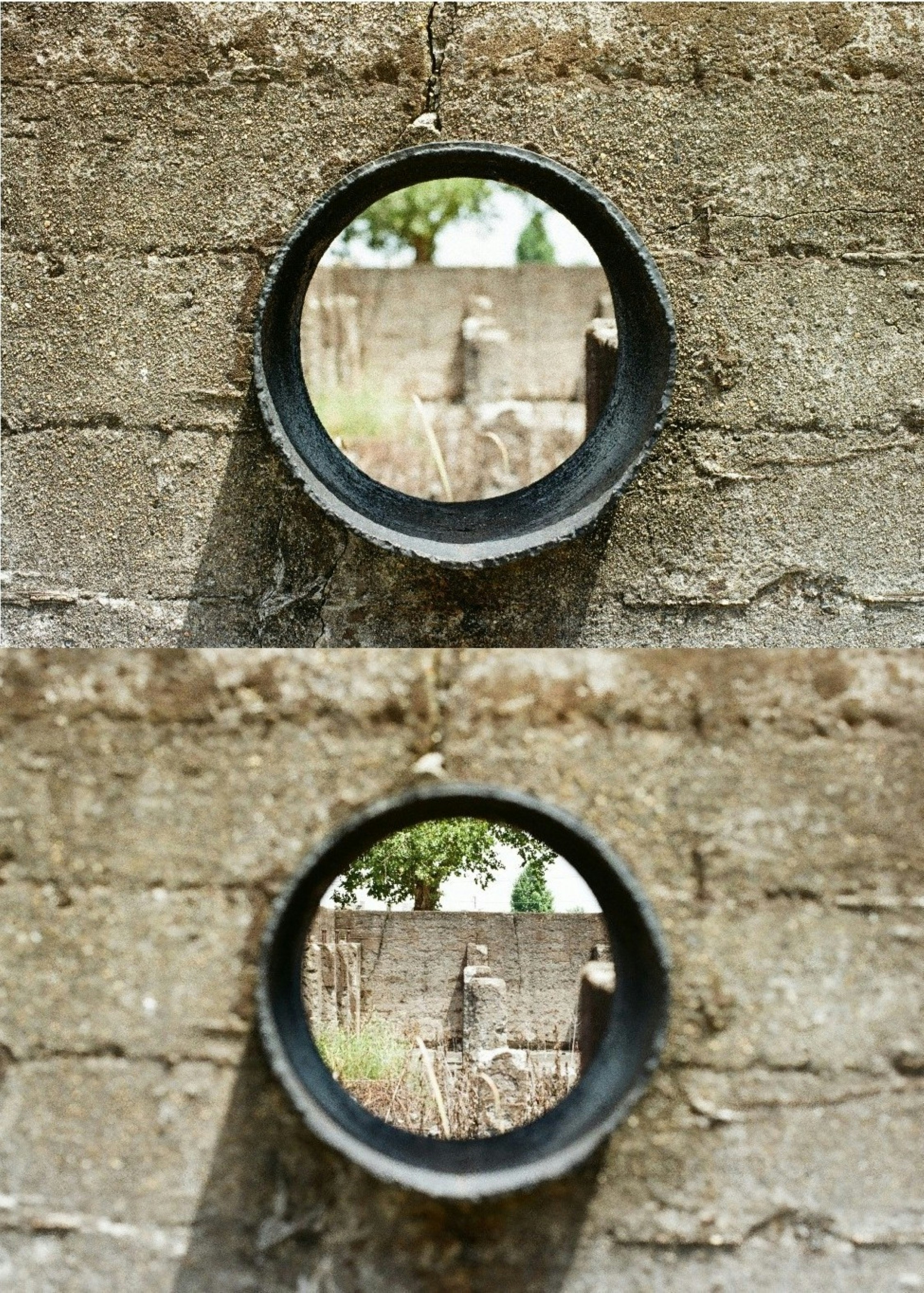 Circular concrete pipe framing a distant outdoor scene with greenery; a close, centered aperture into a weathered wall. A subtle contrast between rough texture and soft background.